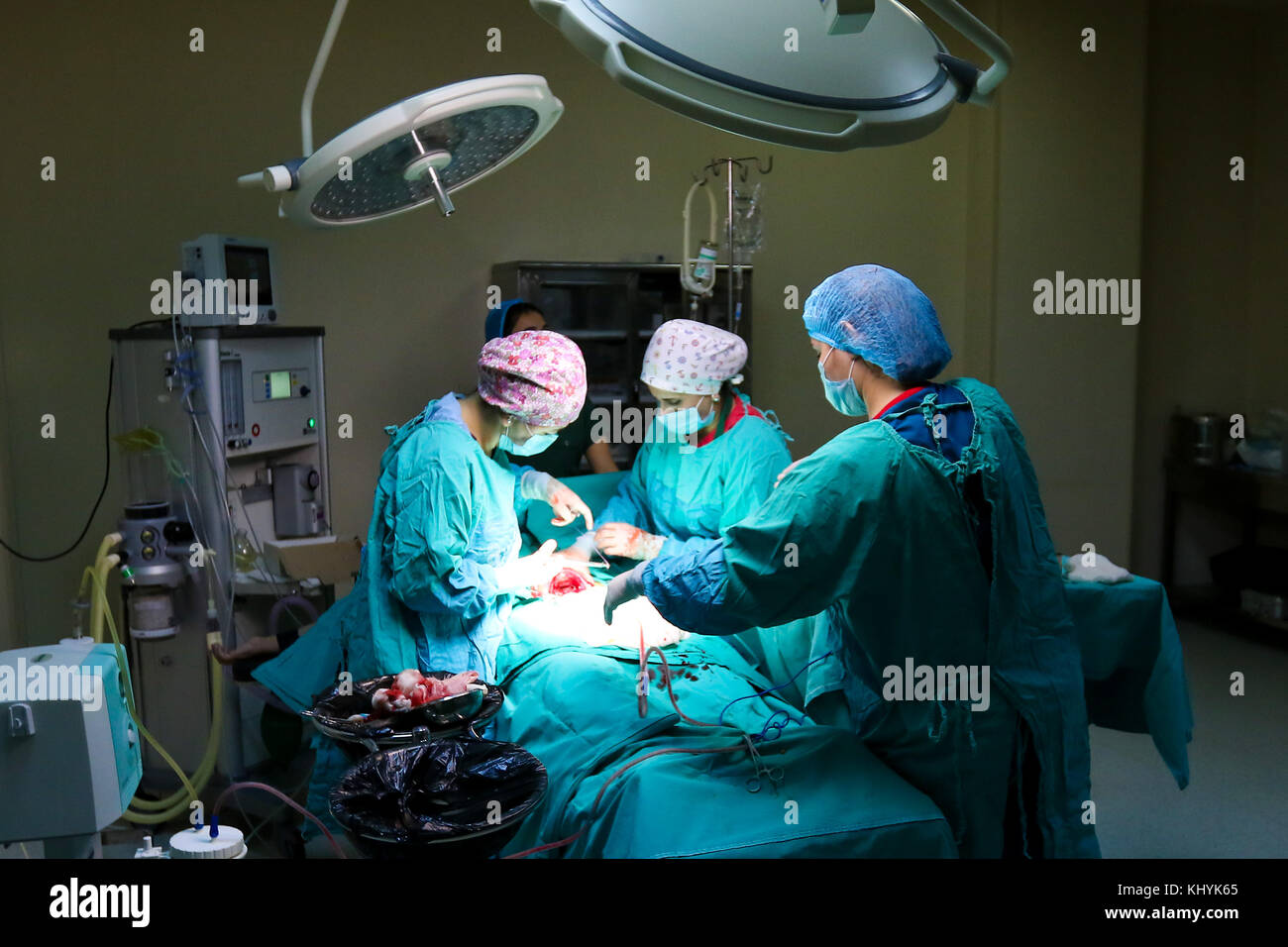 Doctors perform a Cesarean section of an operating room in a maternity ...