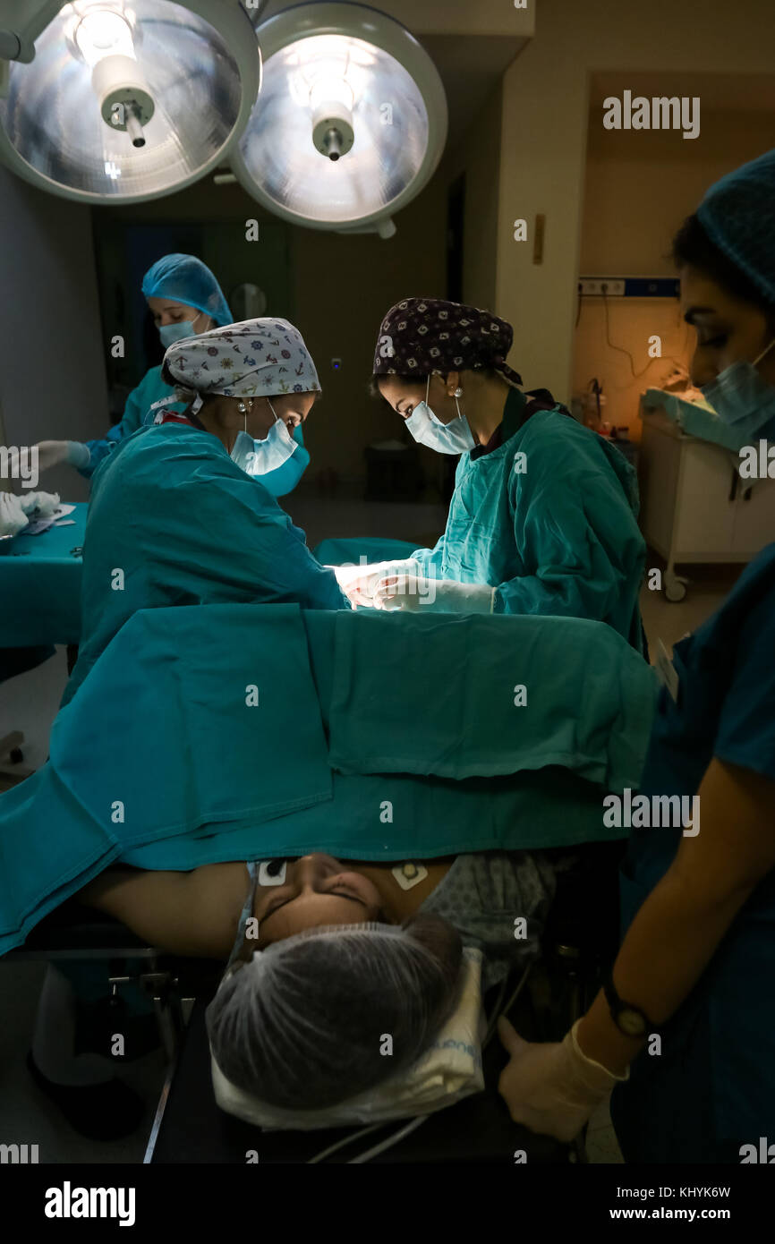 Doctors perform a Cesarean section of an operating room in a maternity ...