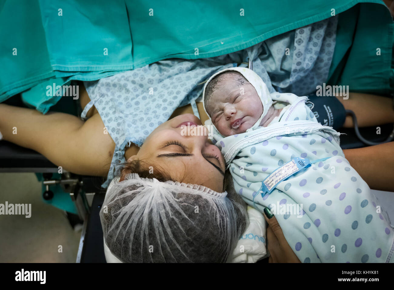 Newborn Baby in smiling mother's in hospital environment Stock Photo ...