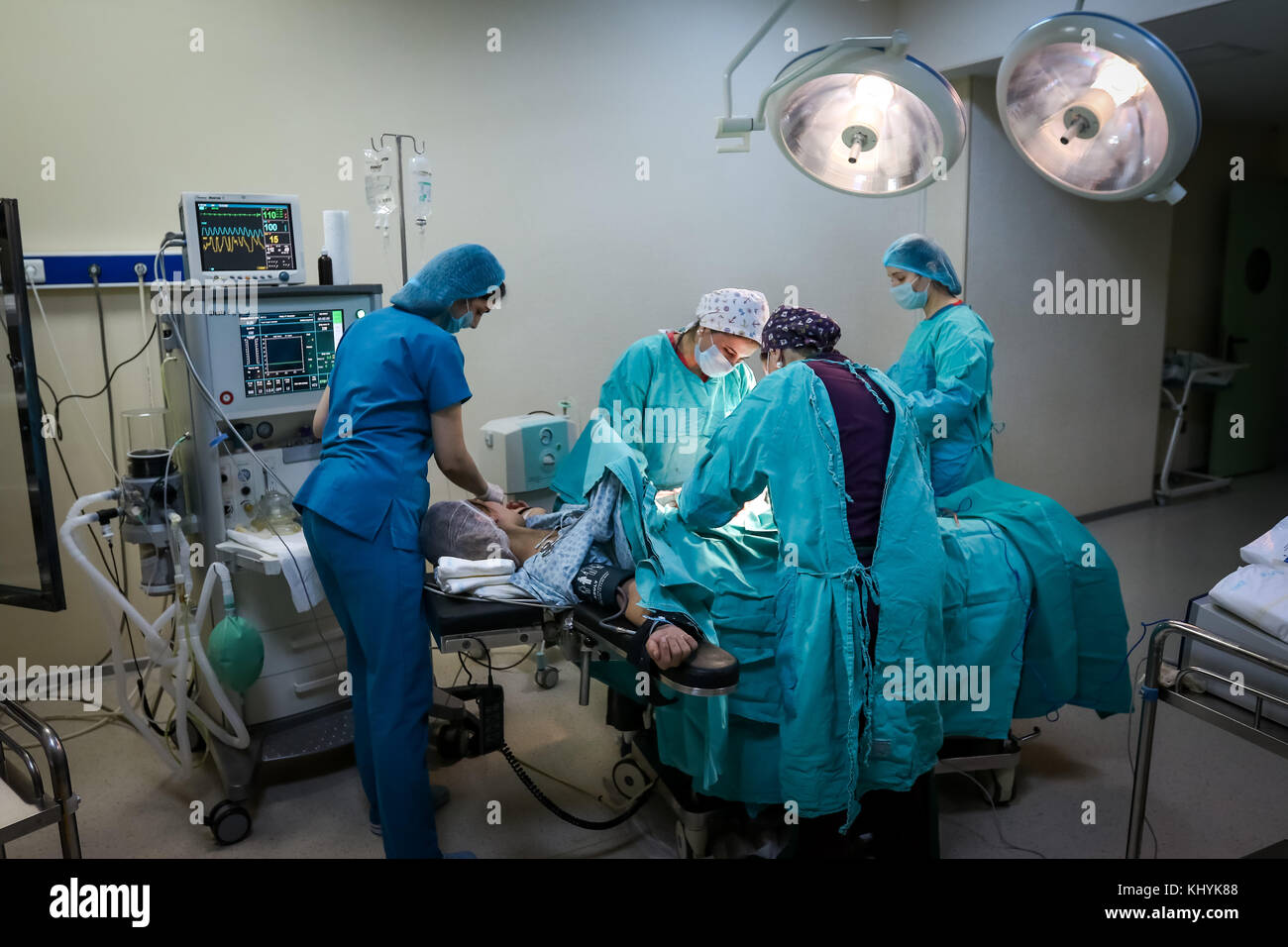 Doctors perform a Cesarean section of an operating room in a maternity ...