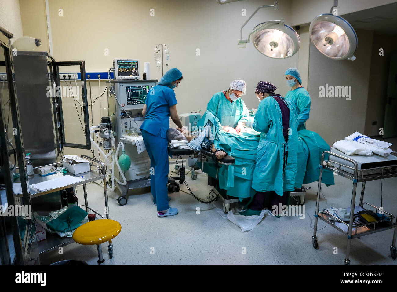 Doctors perform a Cesarean section of an operating room in a maternity ...