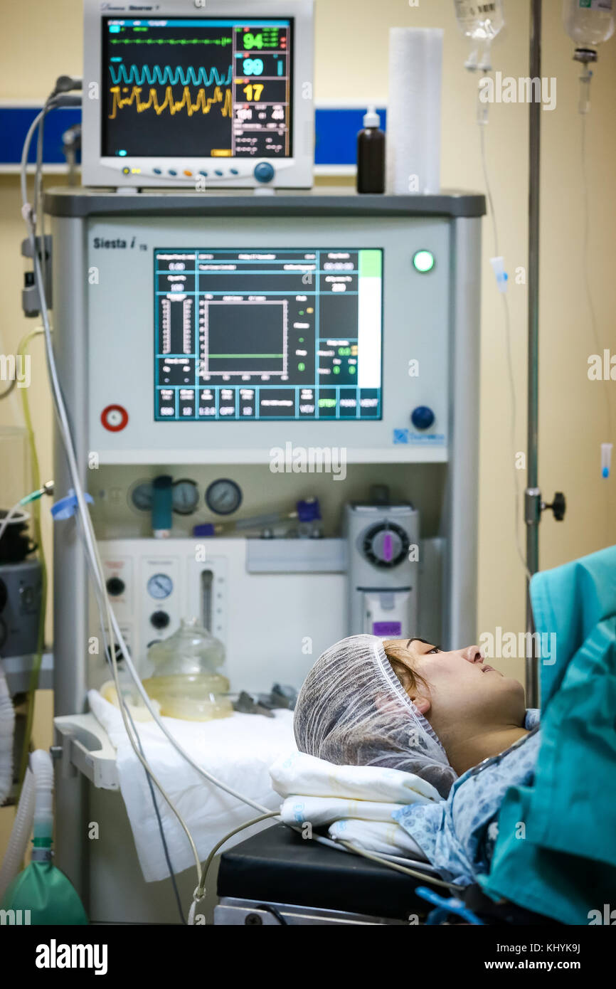 Doctors perform a Cesarean section of an operating room in a maternity ...