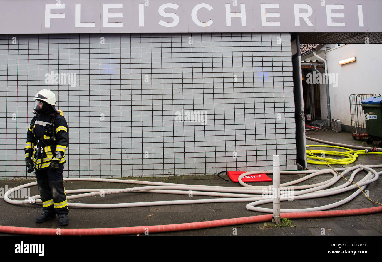 A firefighter stands in front of the butcher during a fire at a butcher ...