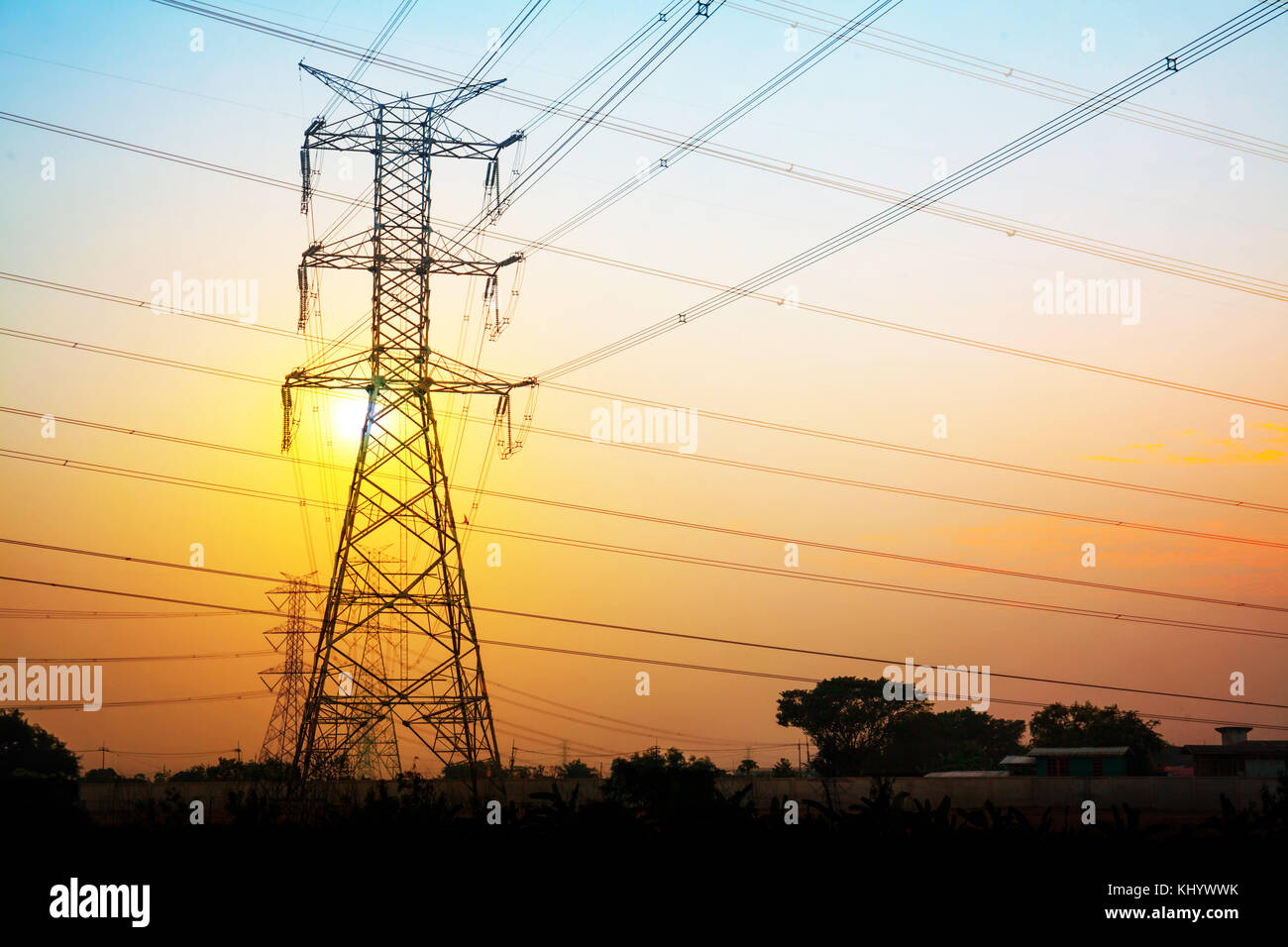 High Voltage power pylon in sunset background Stock Photo - Alamy