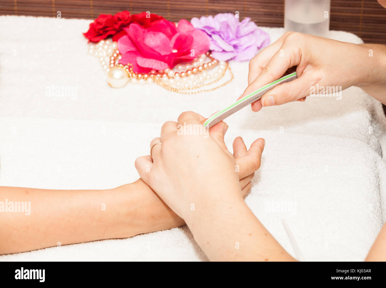 The beautician polish the client's nails before putting nail polish ...