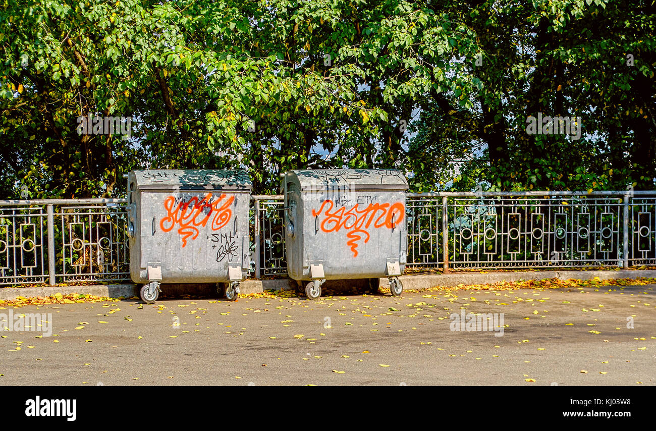 Trash can against green trees background in park Stock Photo - Alamy