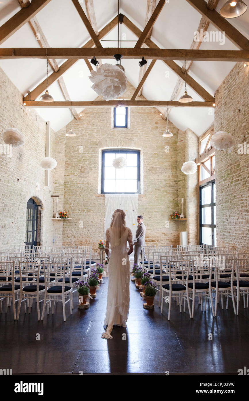 Groom waiting at church altar as bride walks down the aisle Stock Photo ...