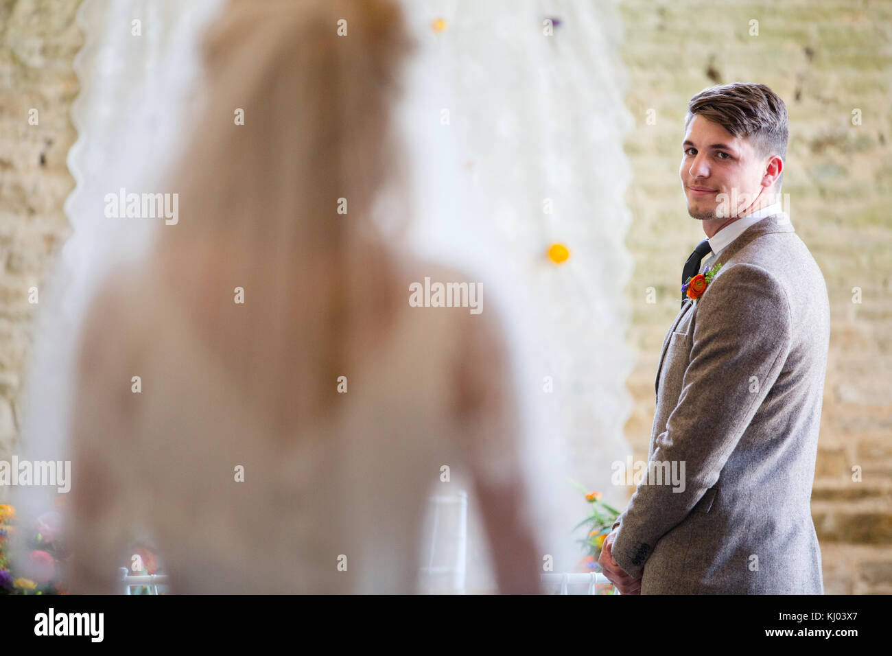Groom waiting at church altar as bride walks down the aisle Stock Photo ...