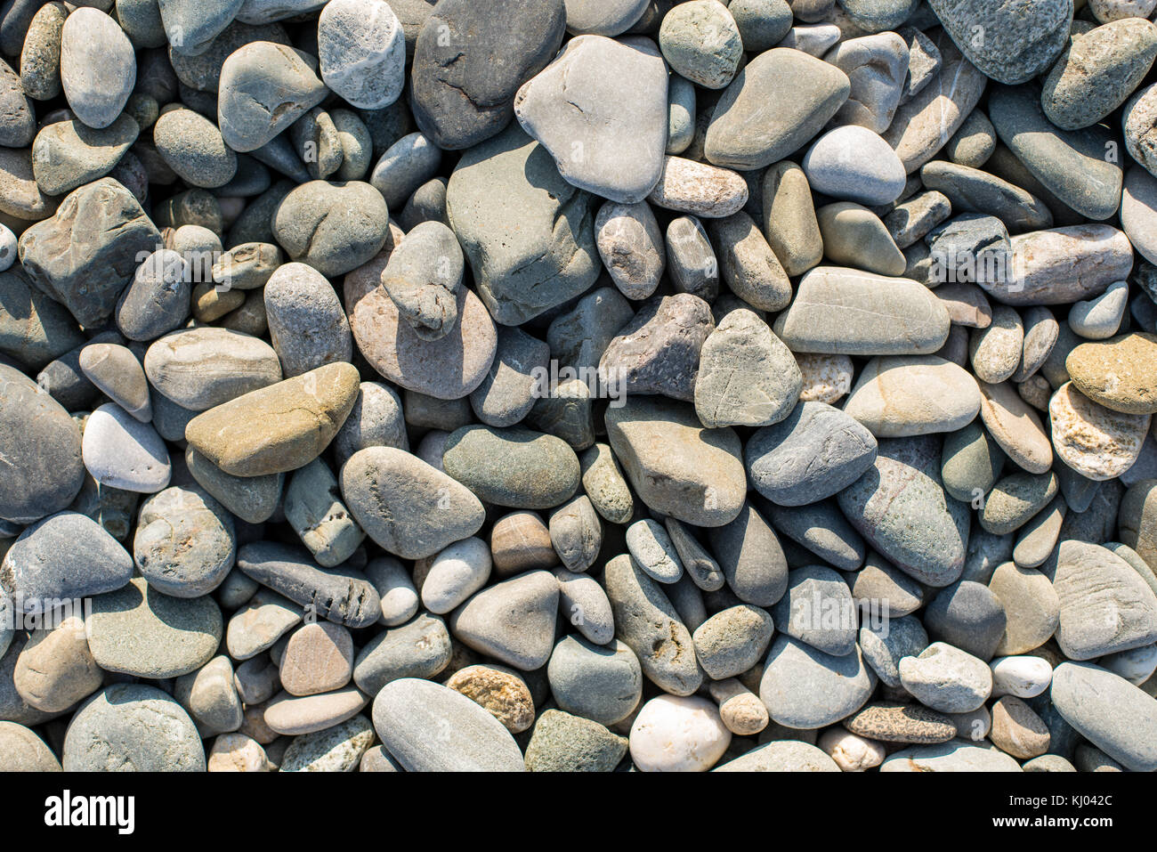 Stones on beach and sea water Stock Photo - Alamy