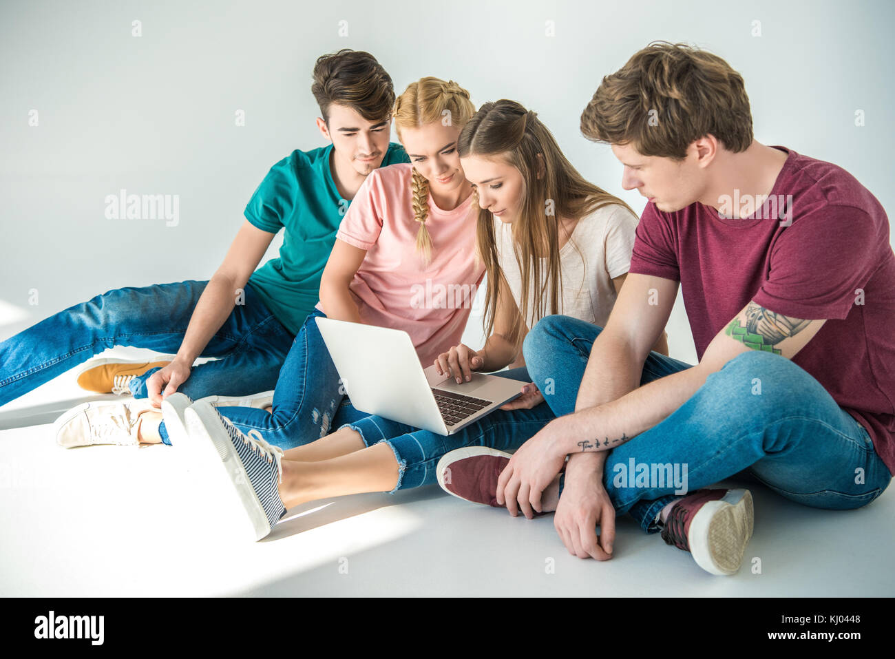 young friends using laptop Stock Photo - Alamy