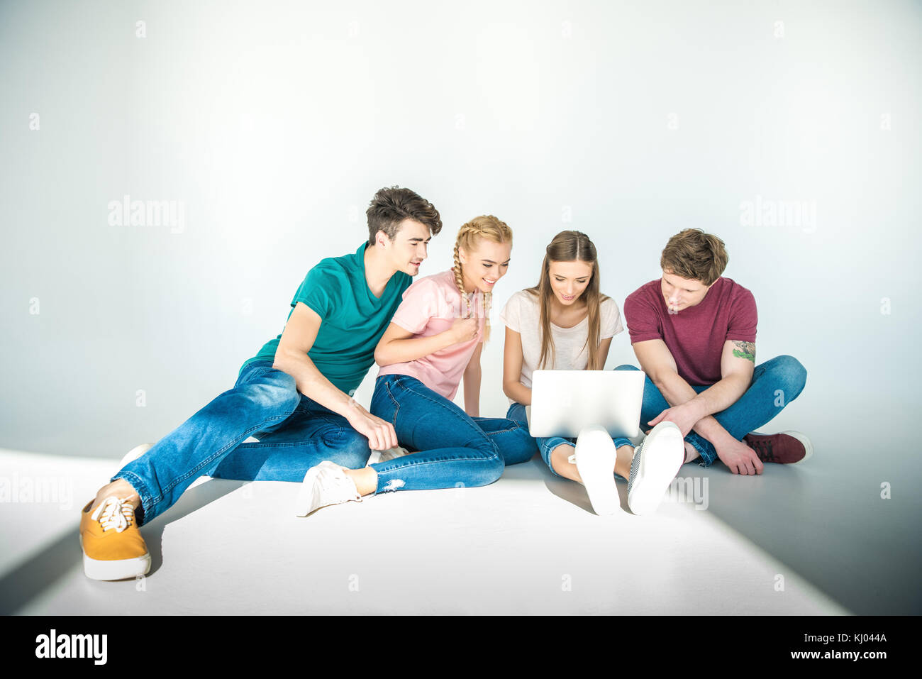 young friends using laptop Stock Photo - Alamy