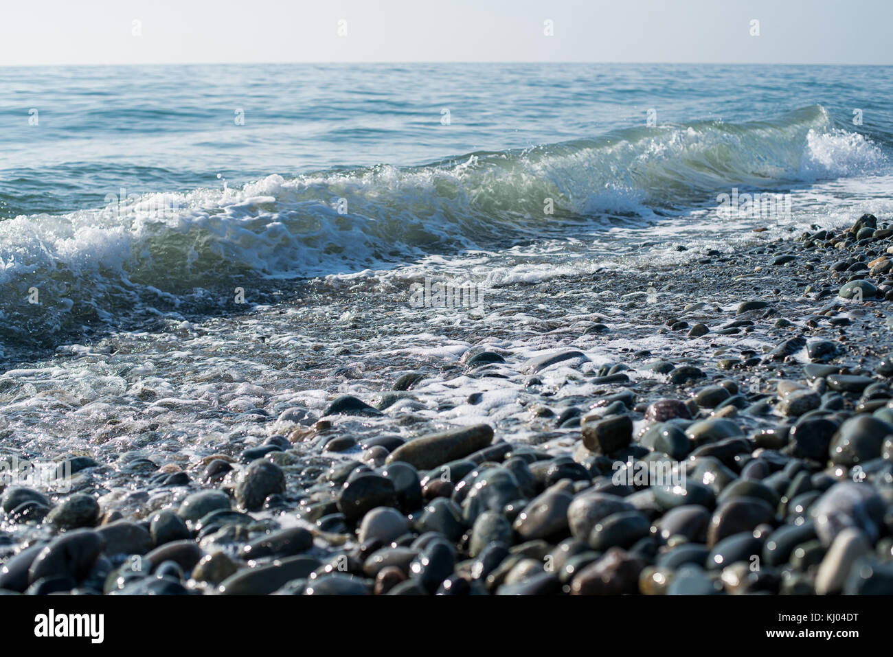 Stones on beach and sea water Stock Photo - Alamy