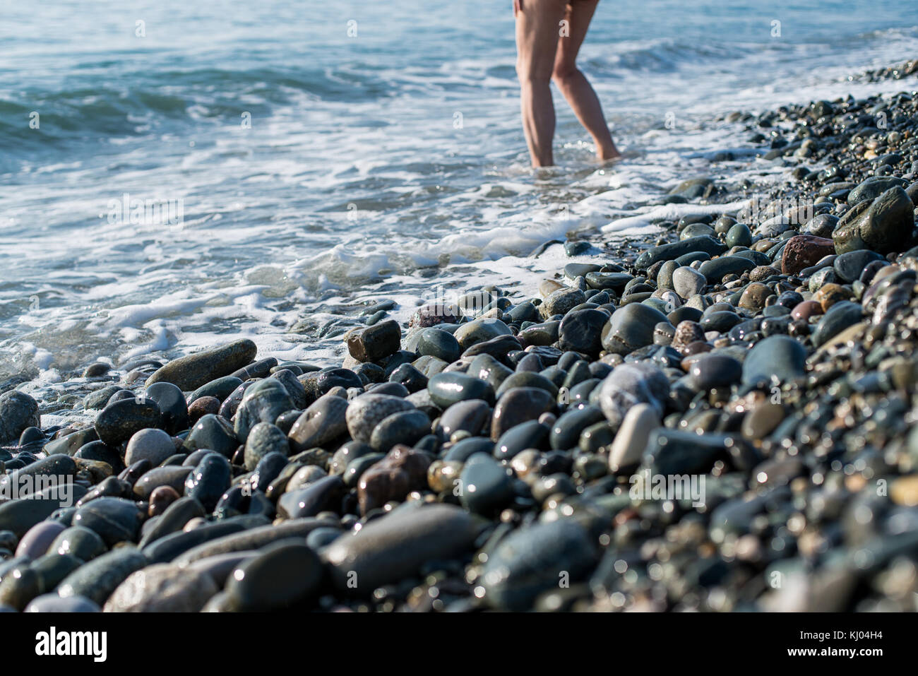 Stones on beach and sea water Stock Photo - Alamy