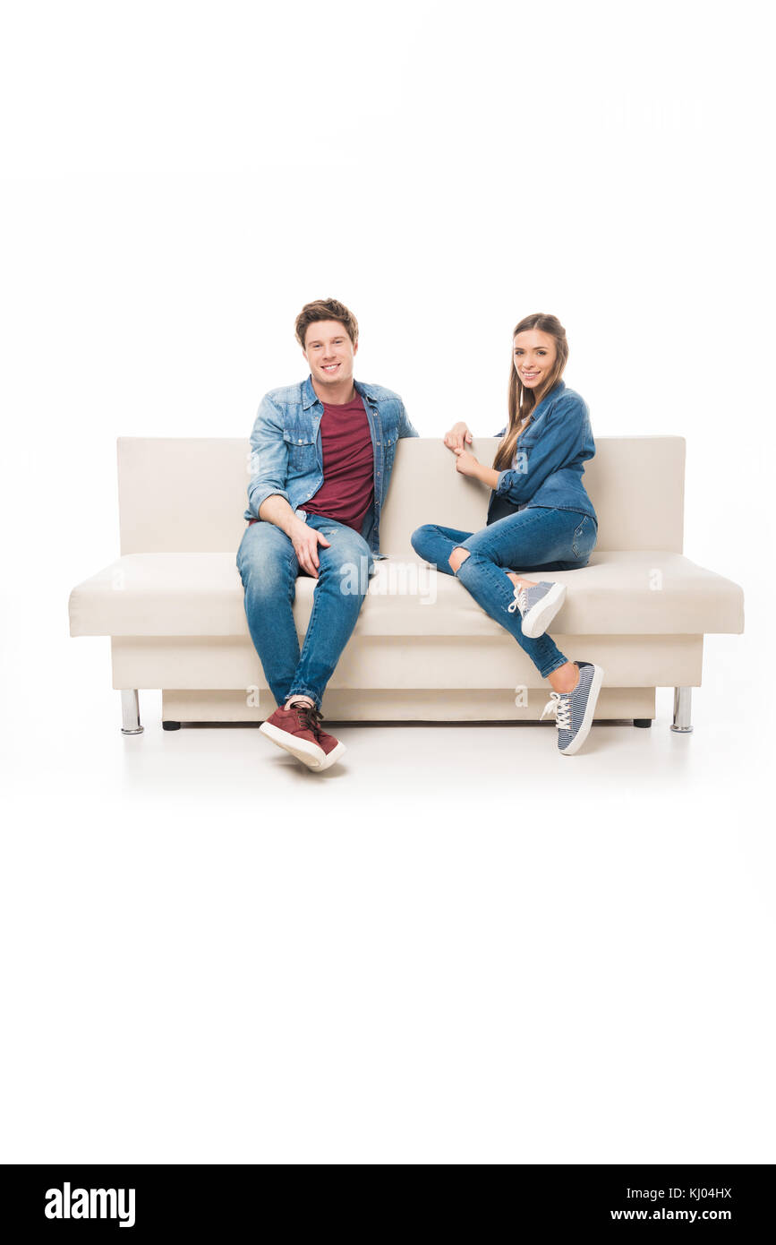 Couple sitting on sofa Cut Out Stock Images & Pictures - Alamy