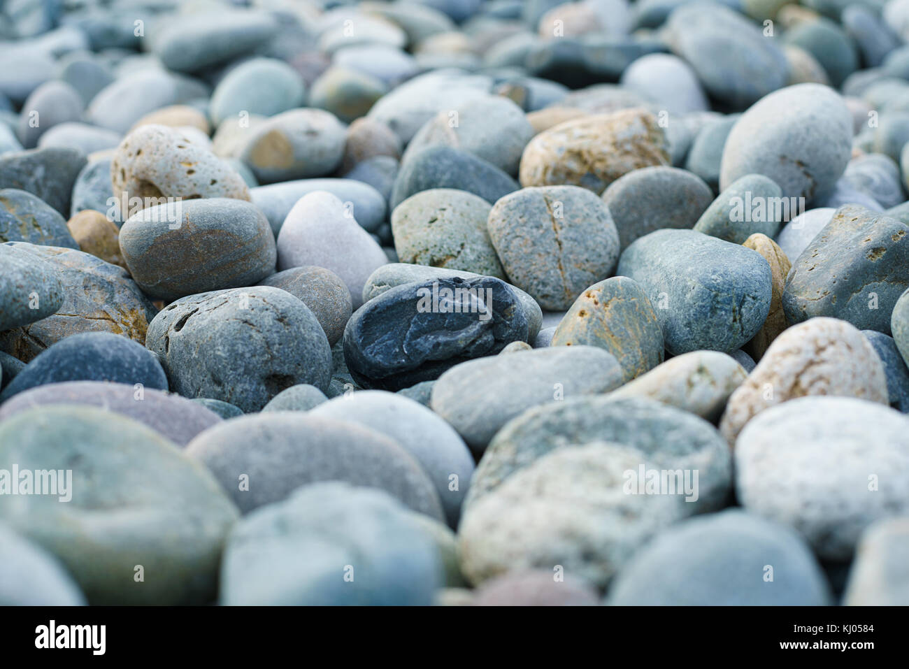 Stones on beach and sea water Stock Photo - Alamy
