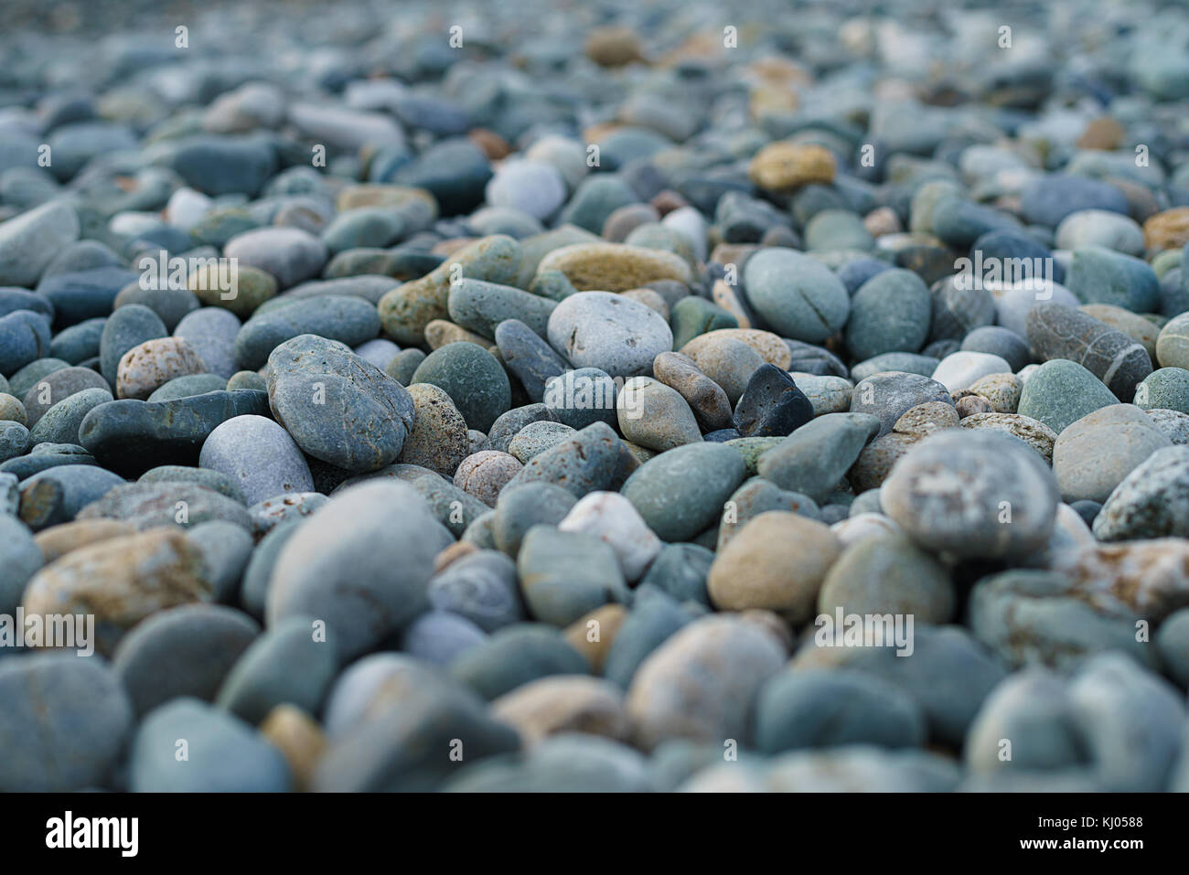 Stones on beach and sea water Stock Photo - Alamy