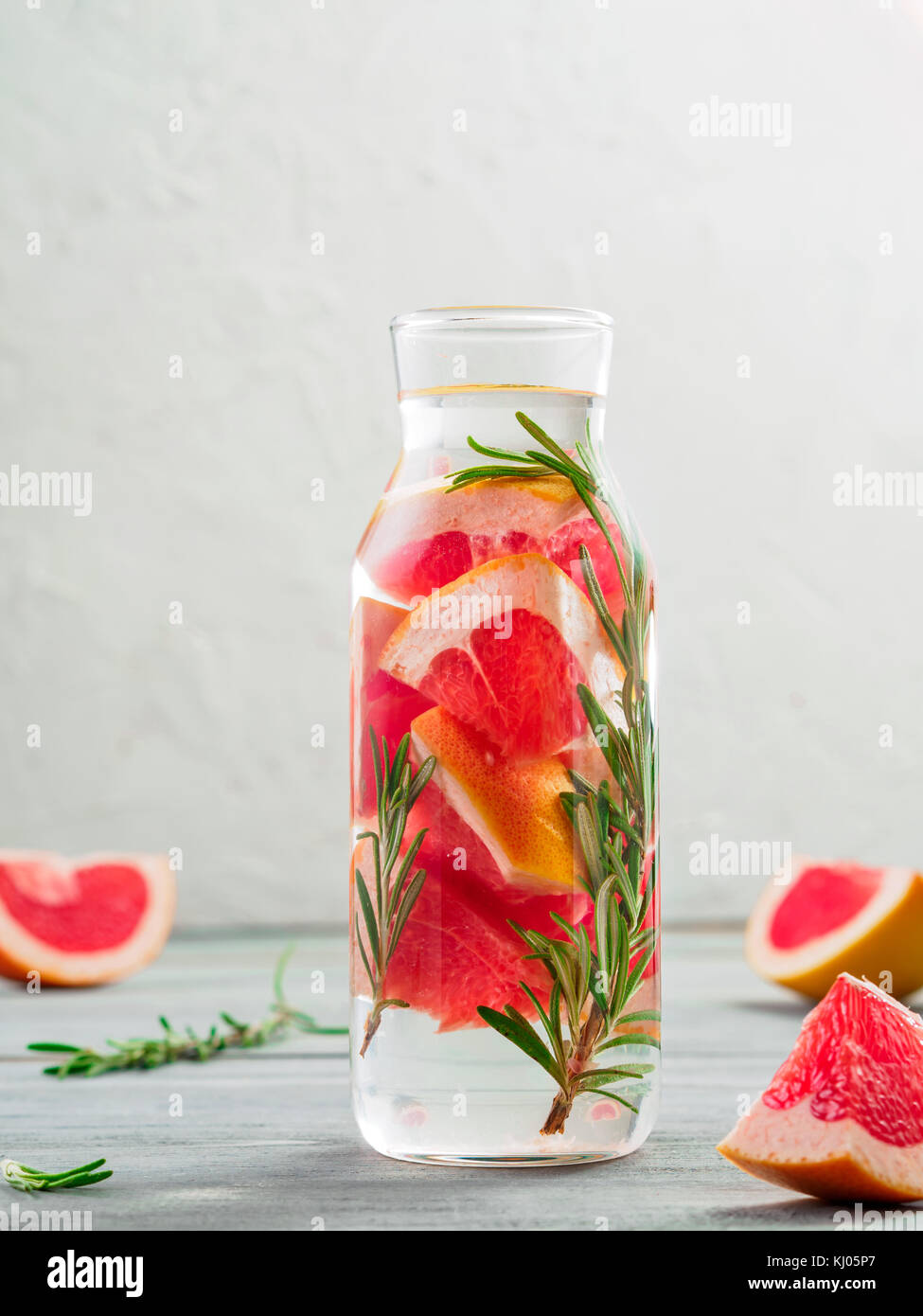 infused detox water with grapefruit and rosemary in glass bottle on ...