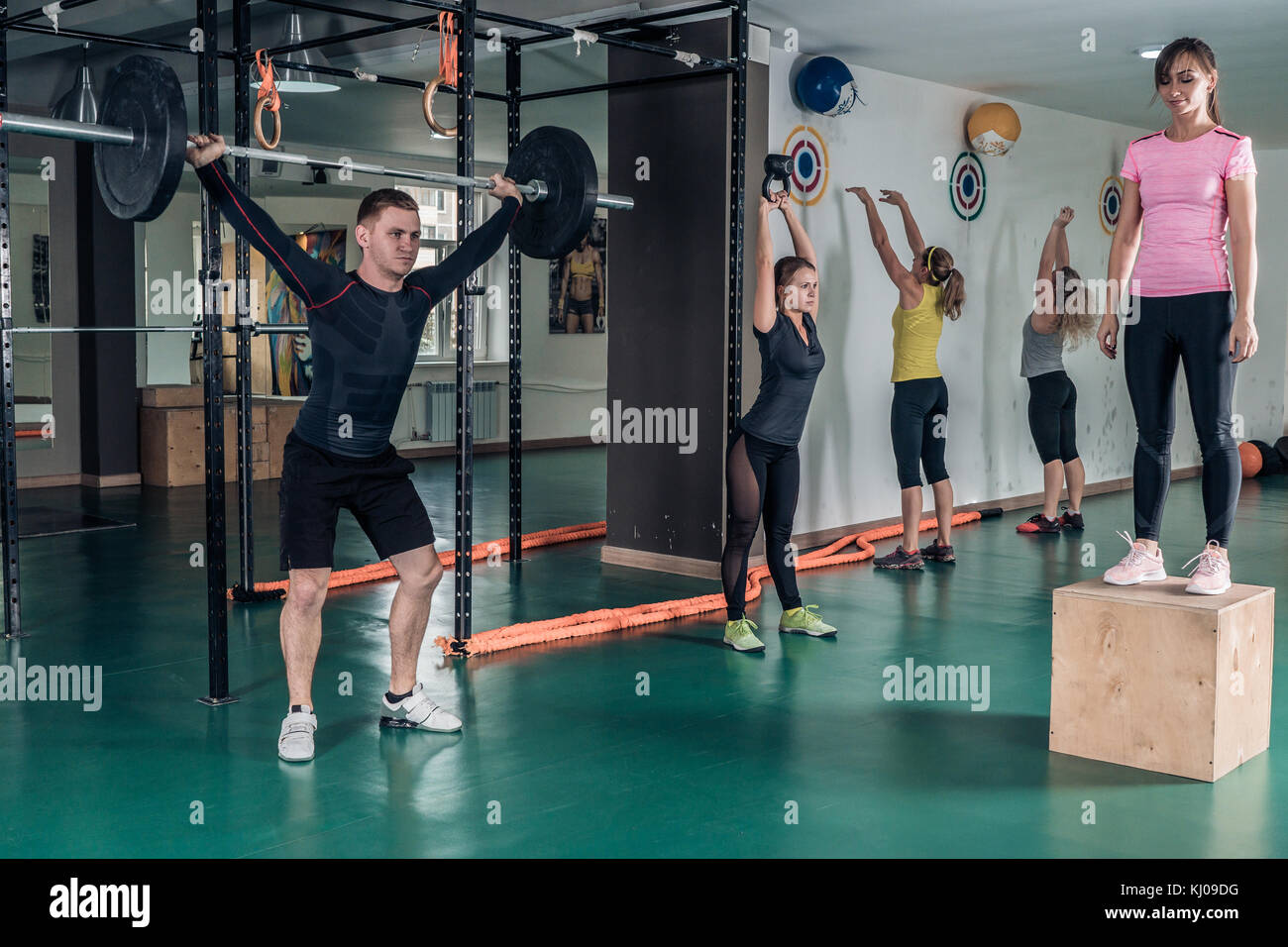 A group of people get physical activity. Strength exercises in the gym ...