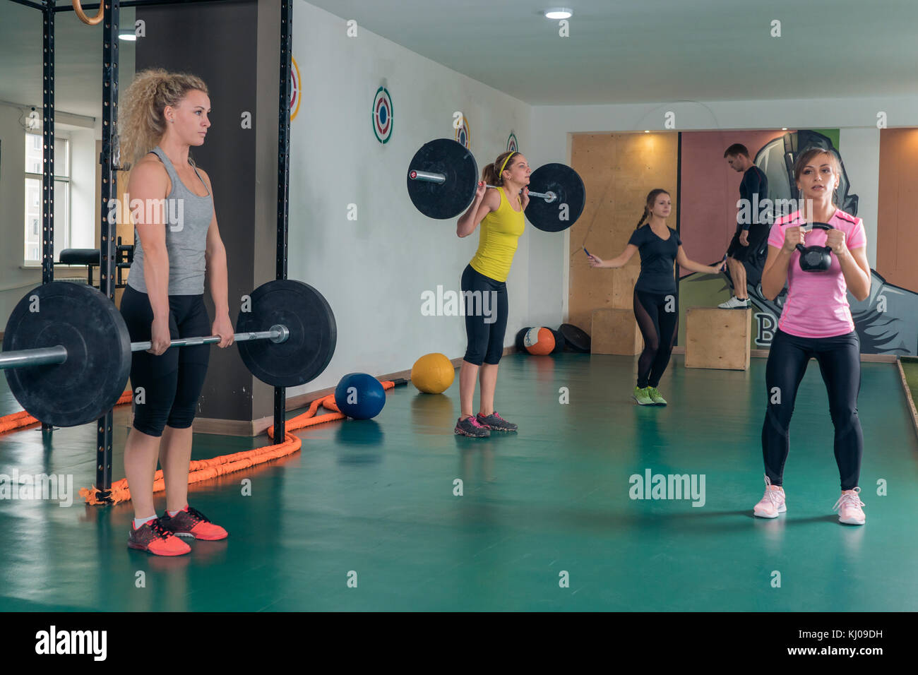 A group of people get physical activity. Strength exercises in the gym ...