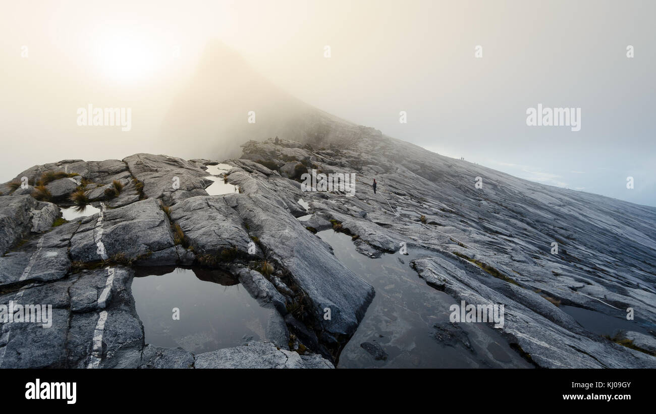 Barren rocky slopes and ponds of water on Mount Kinabalu, a volcano in ...