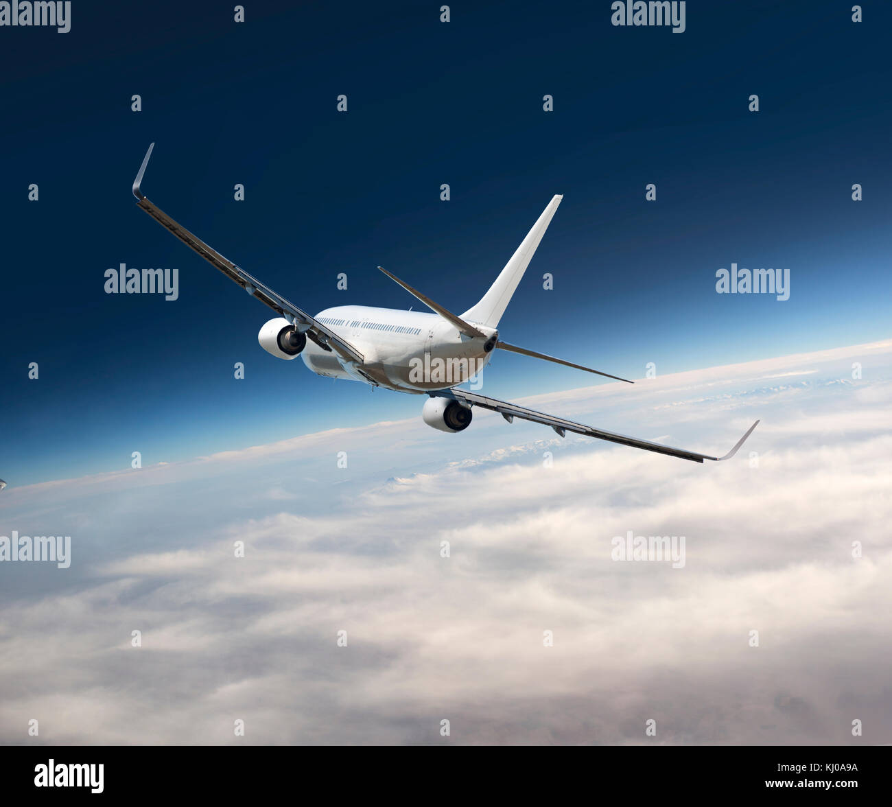 Heavy jumbo jet airplane flying above the clouds Stock Photo - Alamy