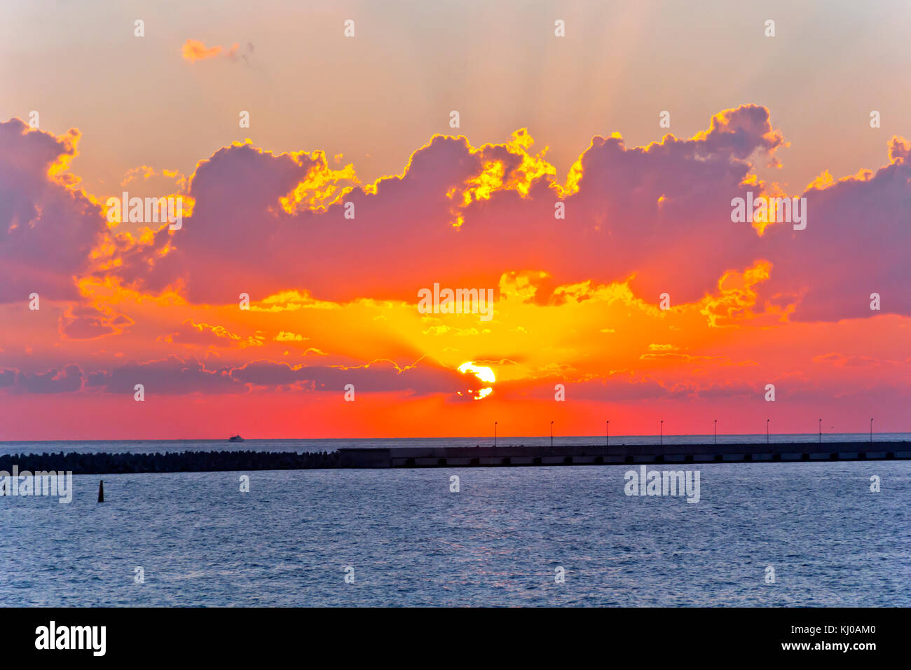 Picturesque skyscape of evening sea with red sunset Stock Photo - Alamy