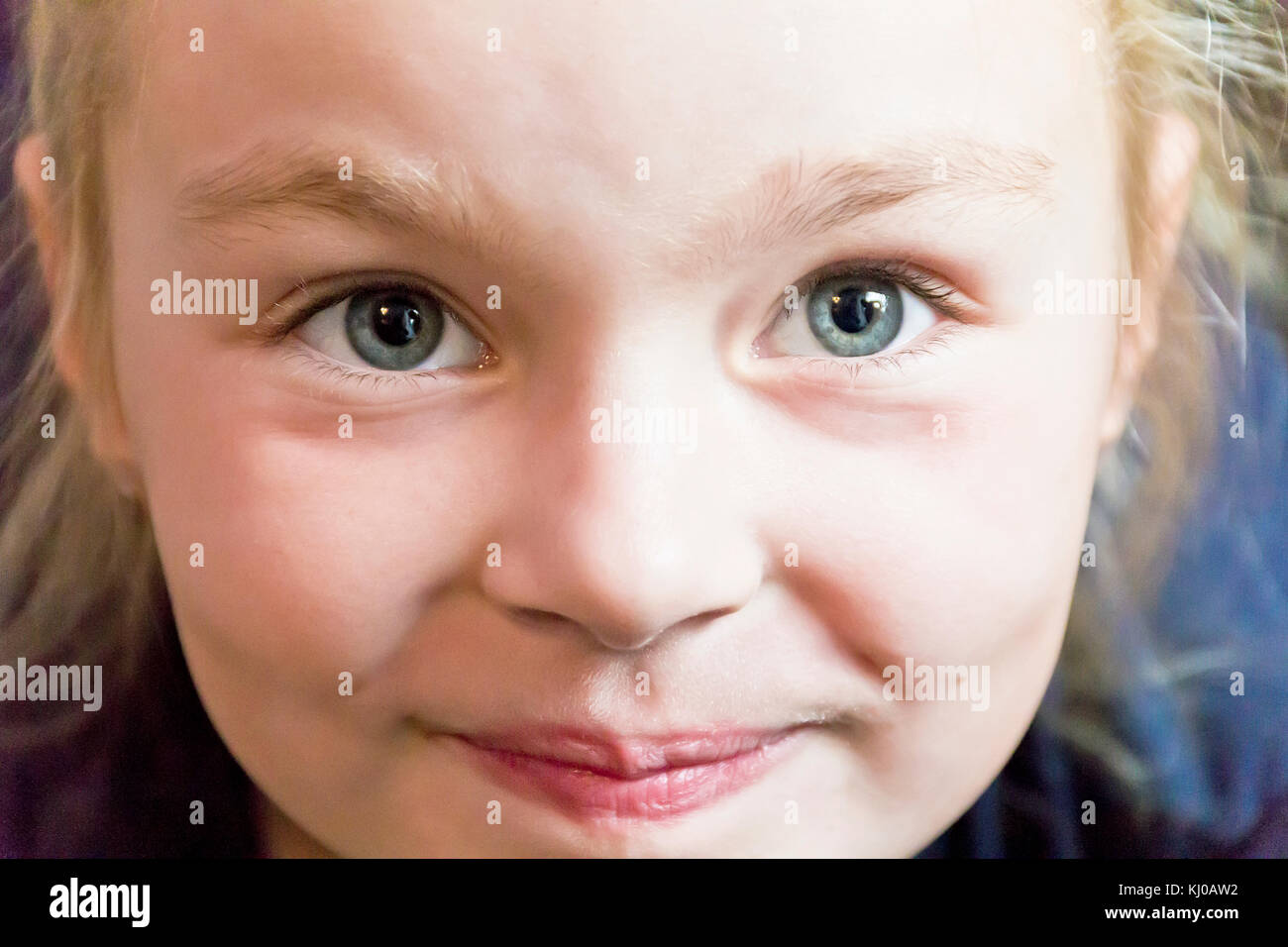 Cute smiling girl with blond hair with big blue eyes Stock Photo - Alamy