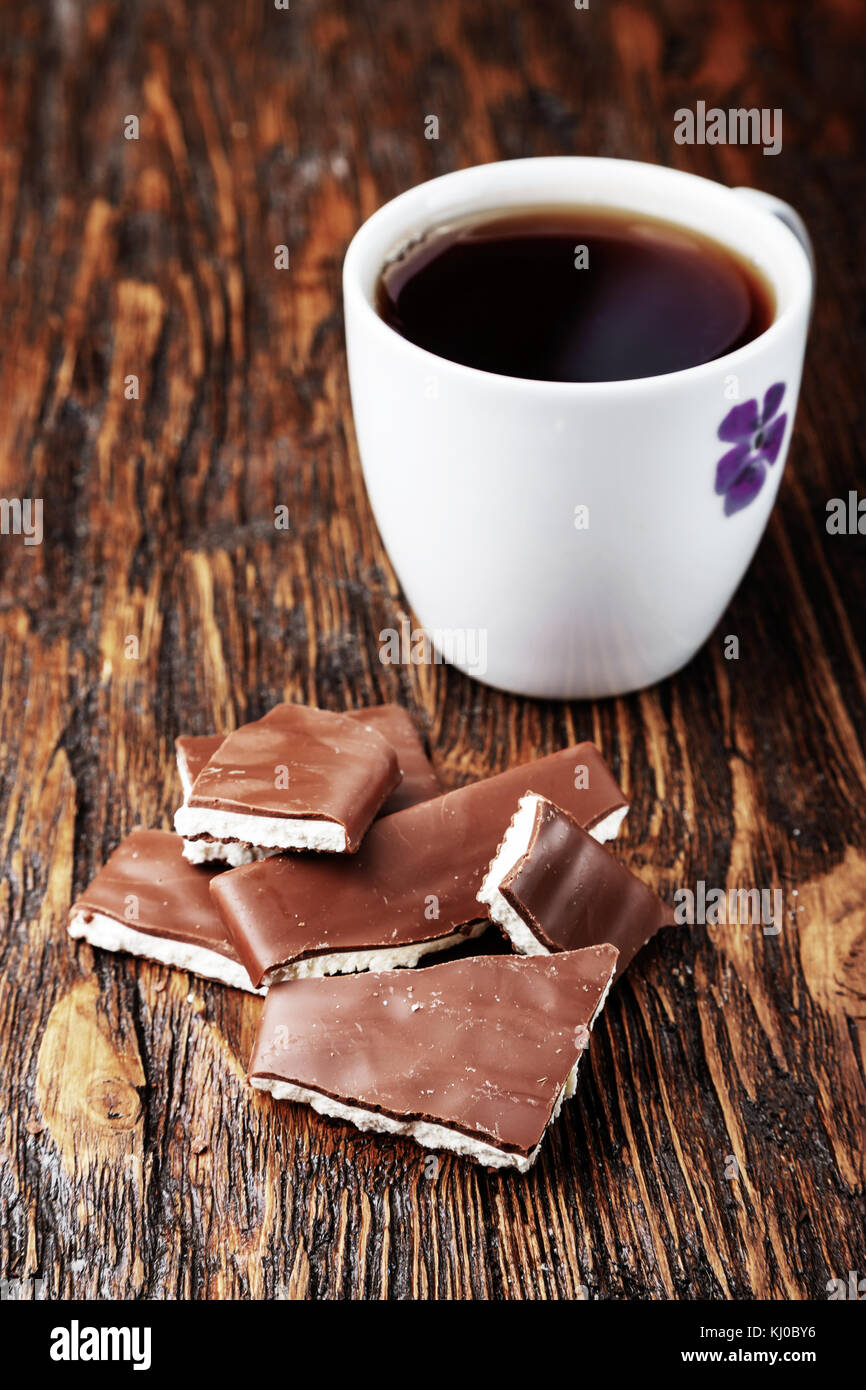 Chopped chocolate and tea on the wooden desk Stock Photo - Alamy