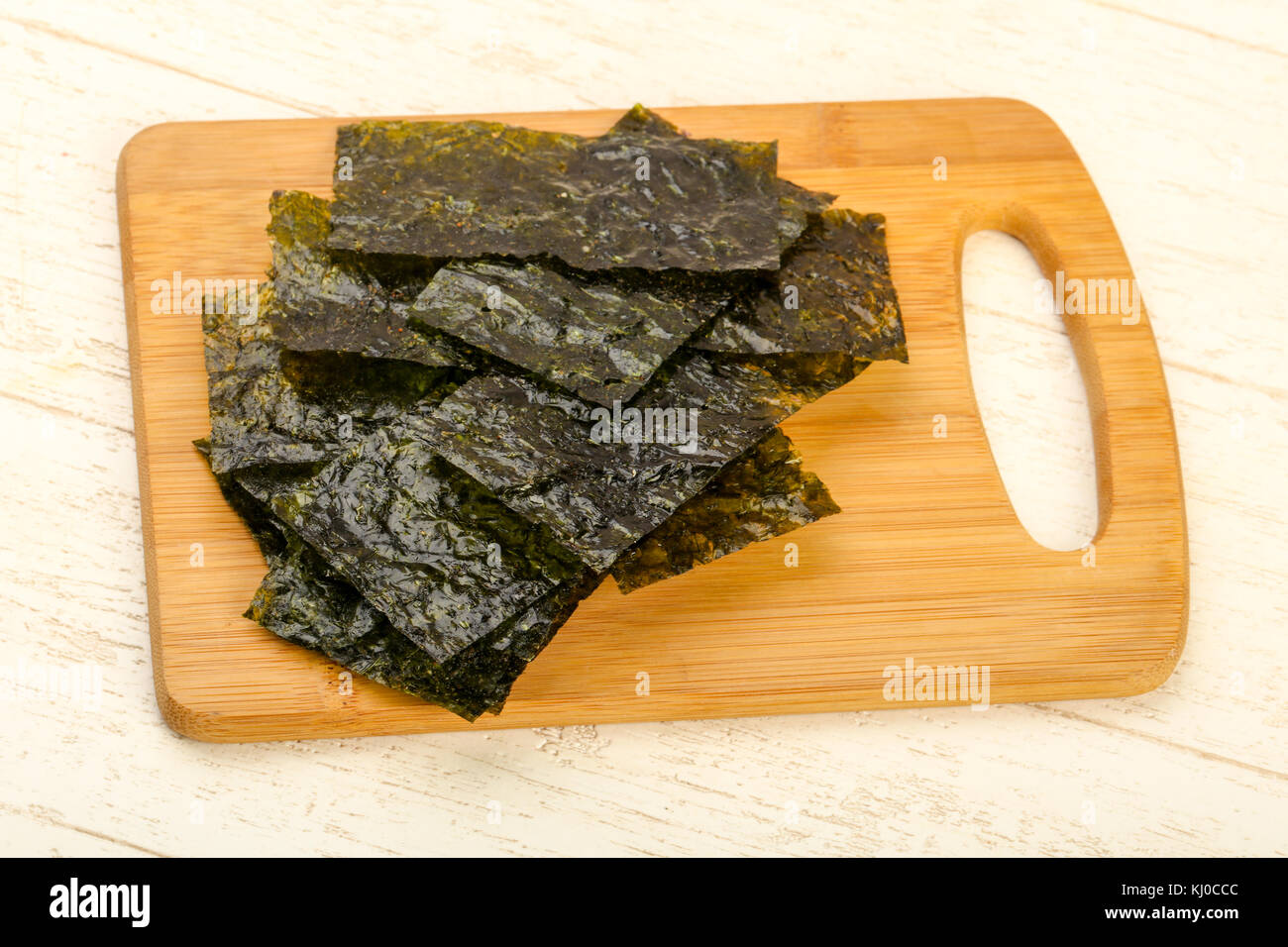 Crispy Nori sheets chips over wooden background Stock Photo - Alamy