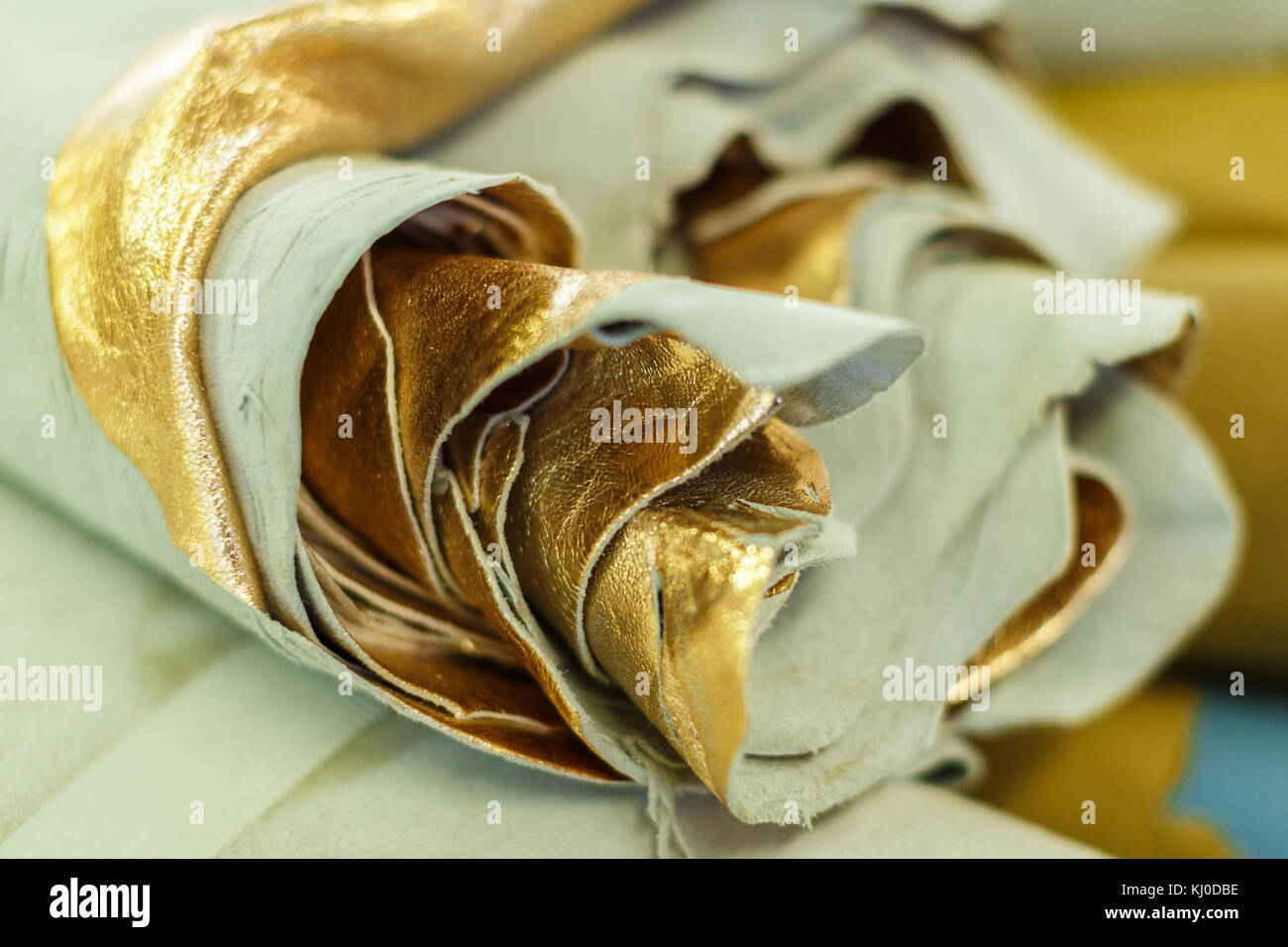 roll of gold colored material. close-up photo Stock Photo - Alamy