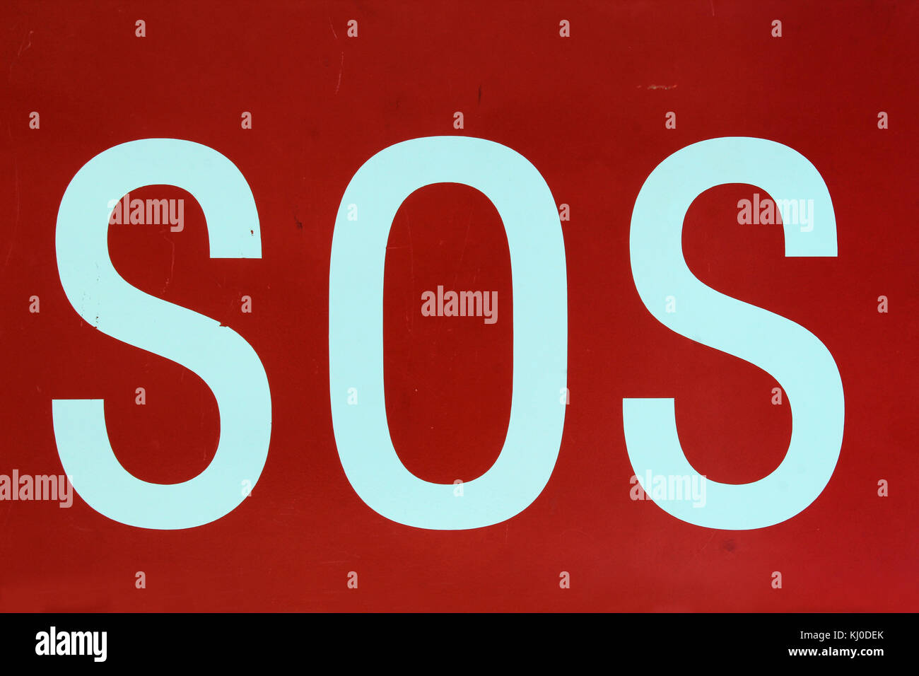 Detail of red metal sign with text SOS Stock Photo - Alamy