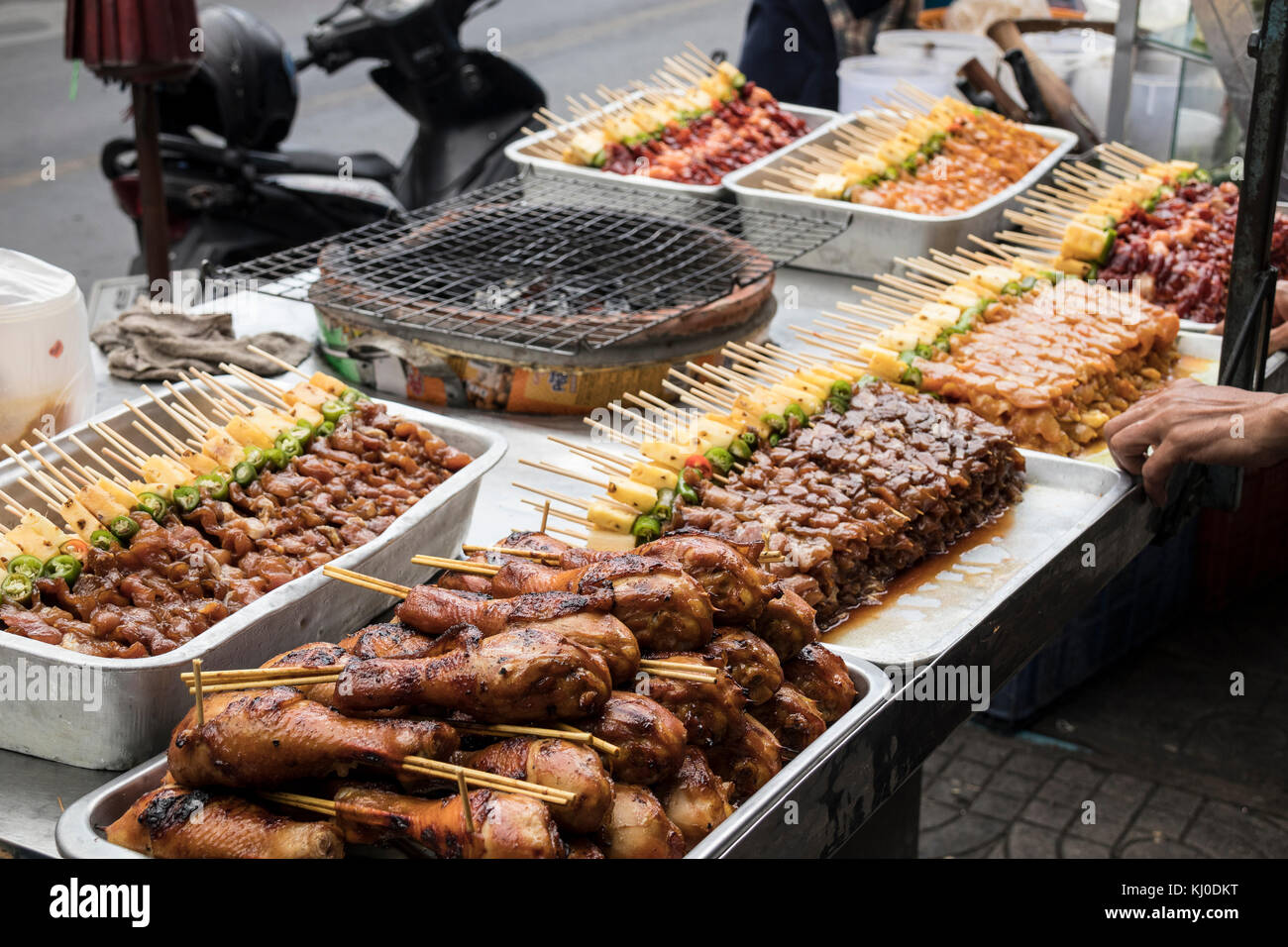 A display of hot food on sticks for sale on a market street stall in ...