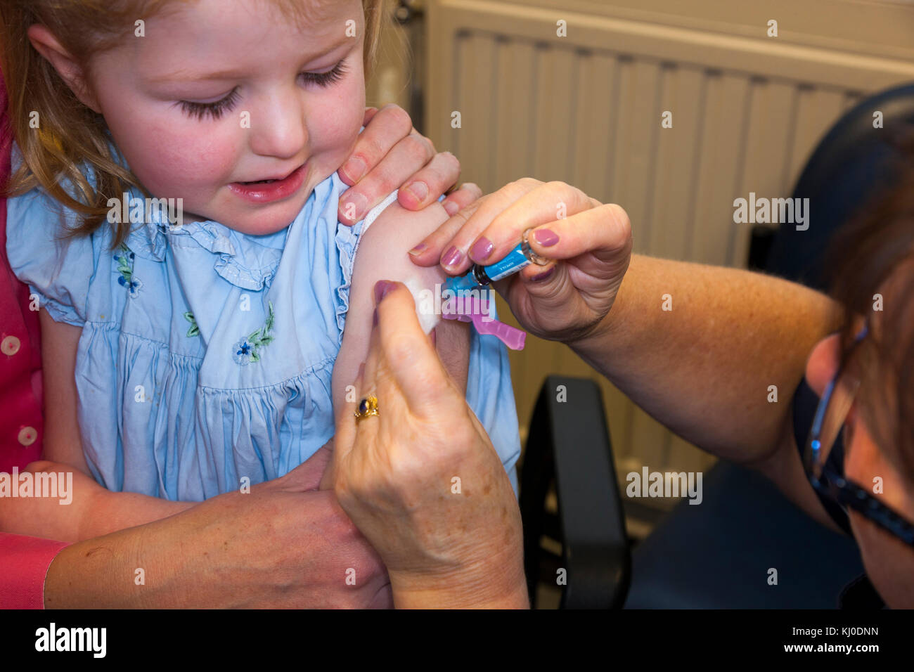 Practice nurse giving NHS 4-in-1 pre-school booster / Pre school ...