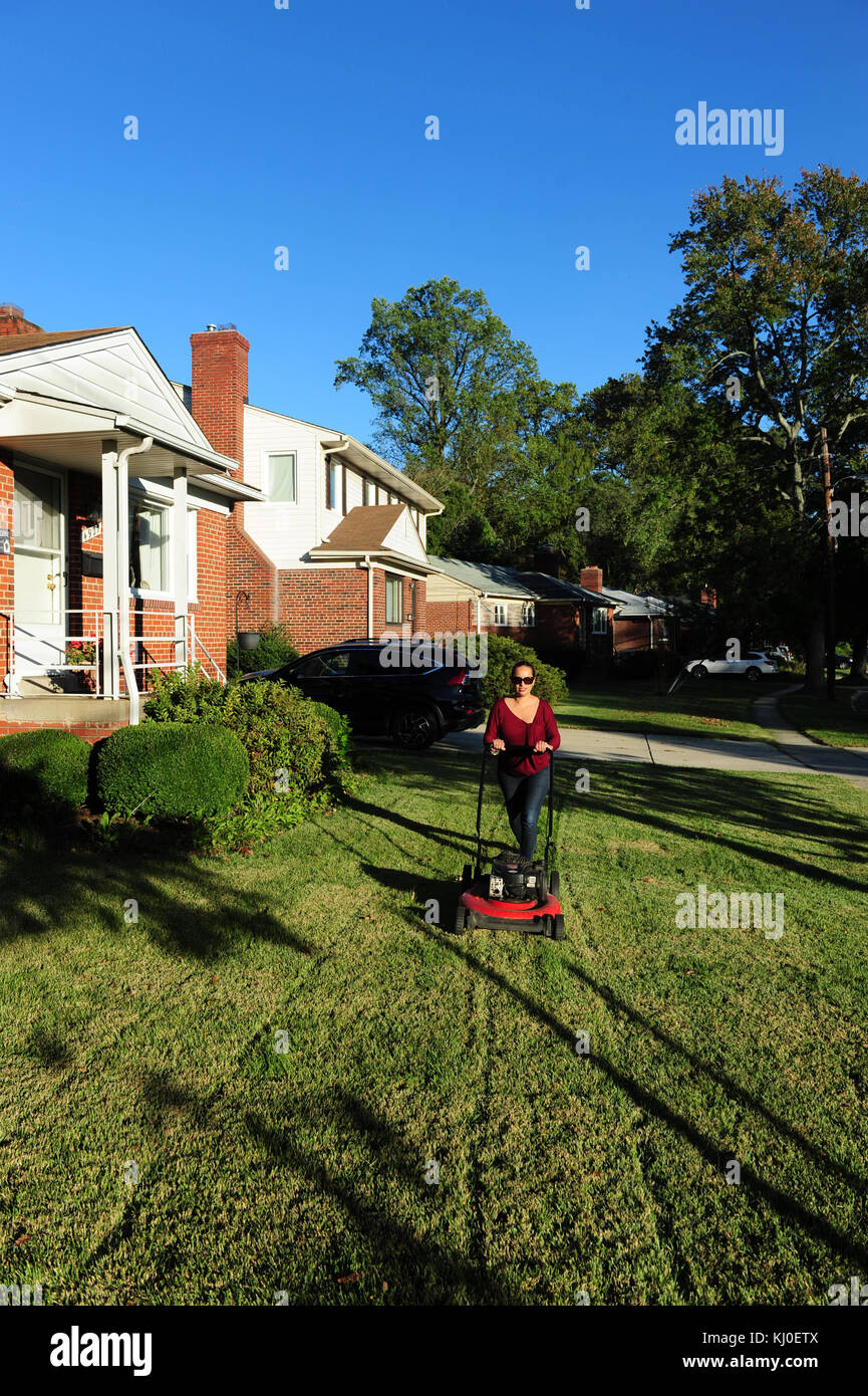 Woman pushing lawn mower hi-res stock photography and images - Alamy