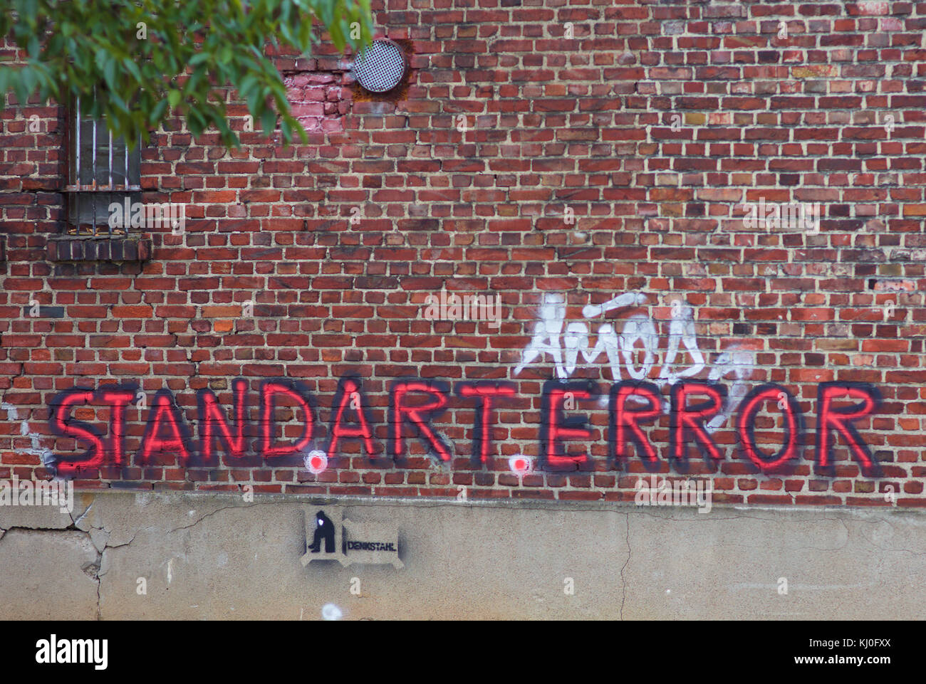 Stand.Art.Error graffiti on brick wall Stock Photo - Alamy