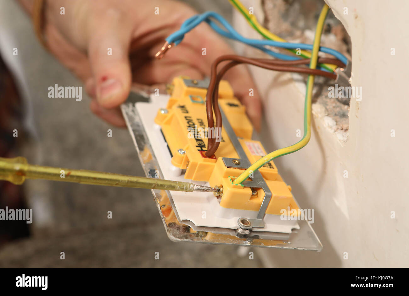 Richard Burr removing an old socket before fitting a USB plug into a ...