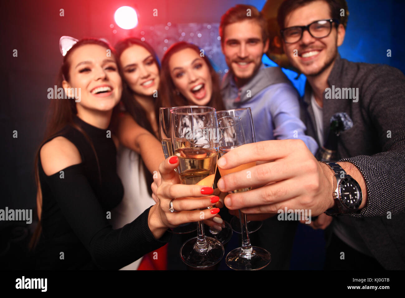 Enjoying amazing party. Group of beautiful young people dancing with ...