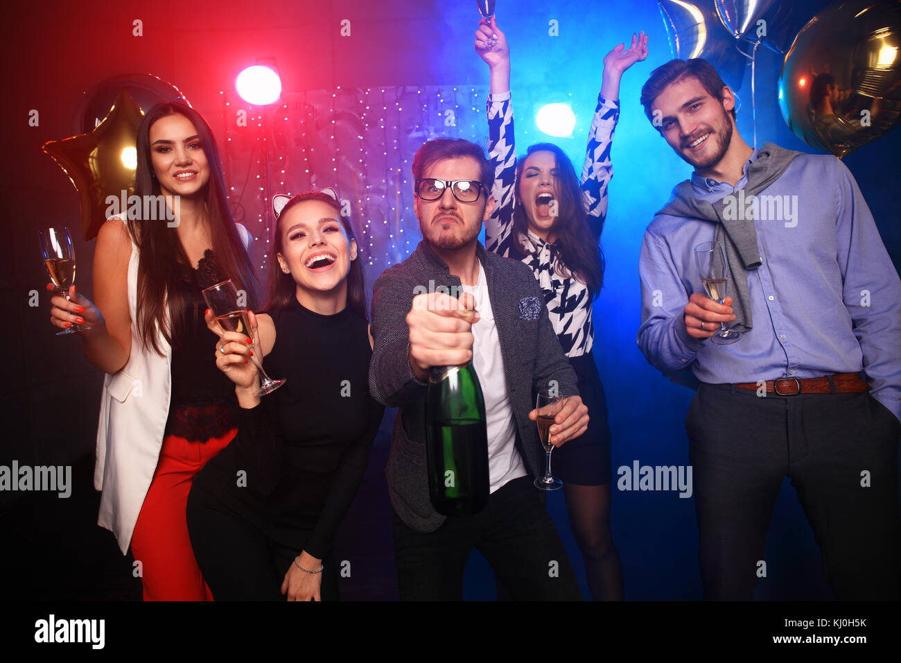 Enjoying amazing party. Group of beautiful young people dancing with ...