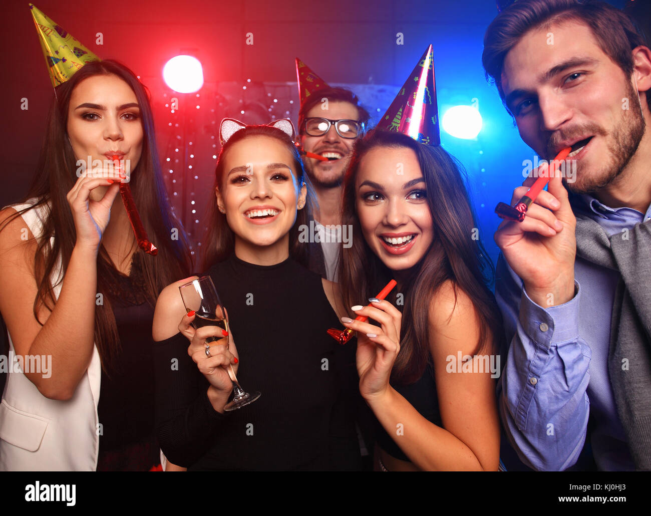 Friends making big party in the night. Five people throwing confetti ...