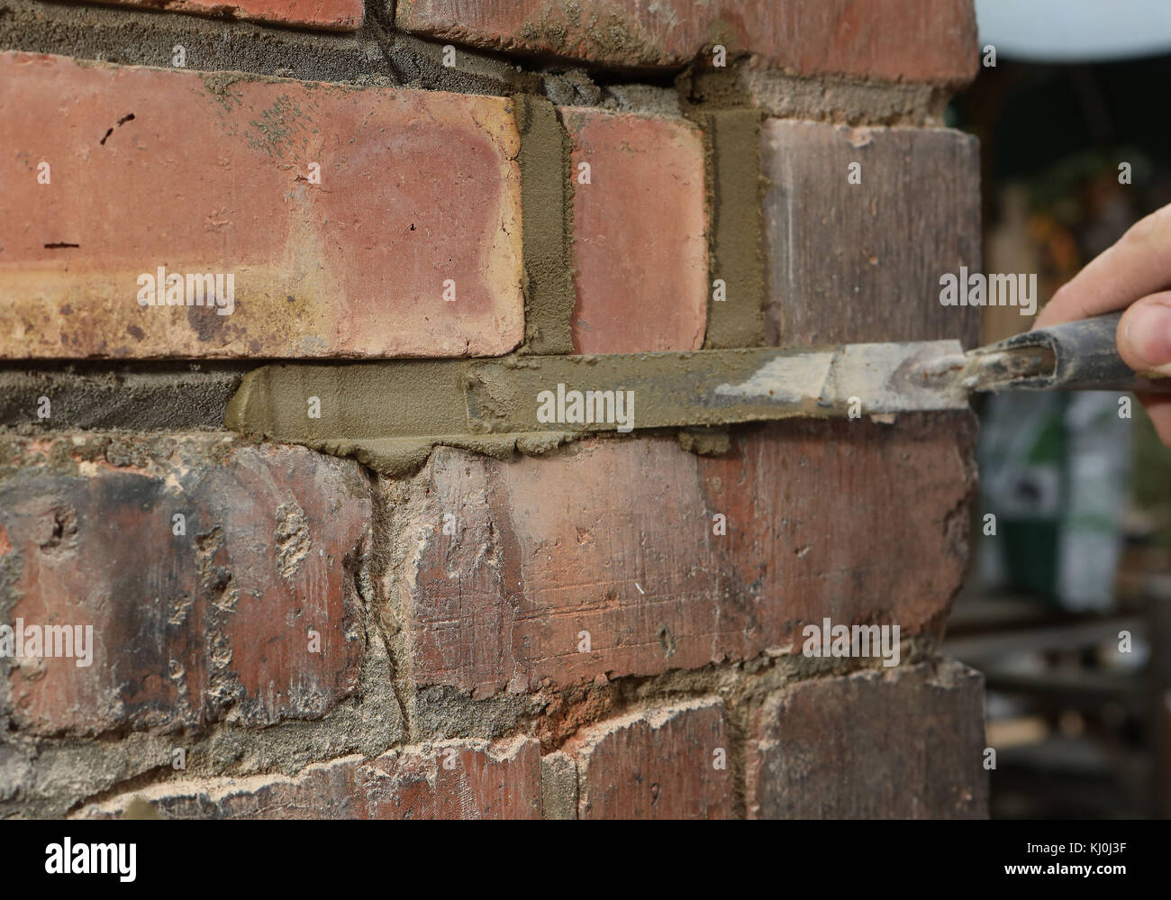 Richard Burr pointing a wall for his DIY feature column Stock Photo - Alamy