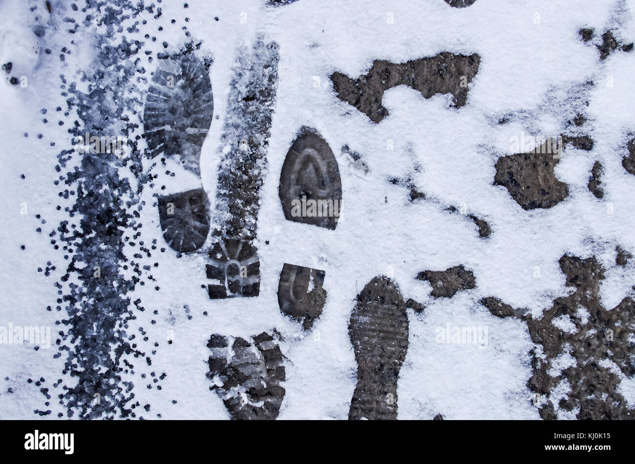 Dirty footprints in the snow winter. Track from boots on the tra Stock ...
