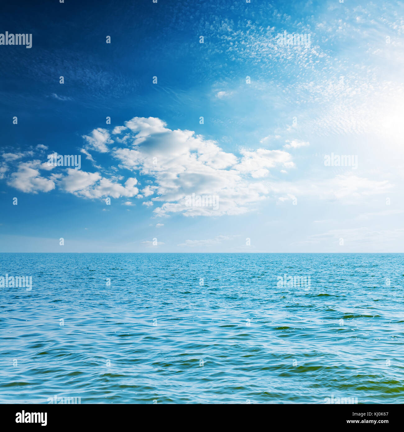blue sunset with clouds over sea Stock Photo - Alamy