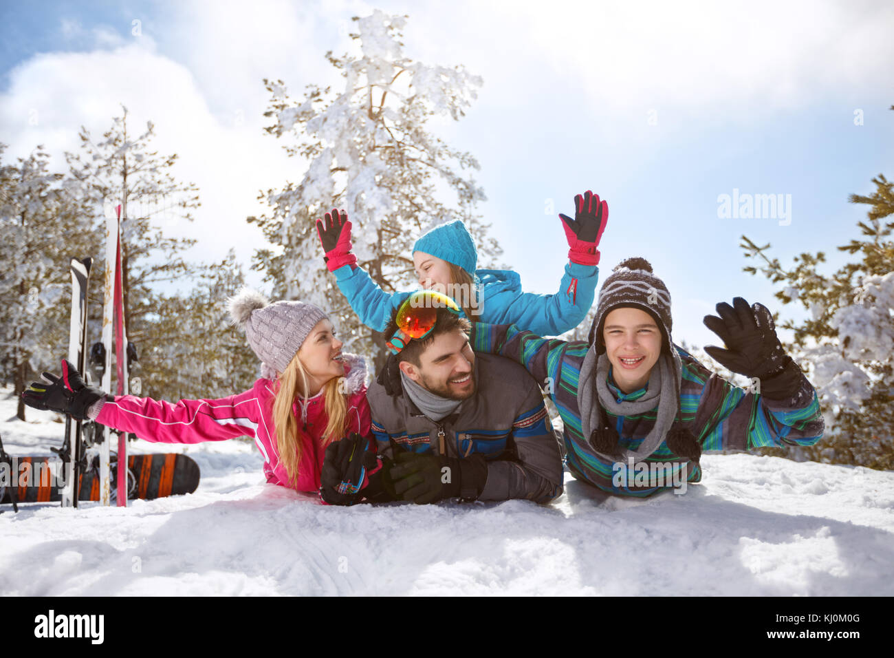Happy family having fun on snow on winter holiday Stock Photo - Alamy