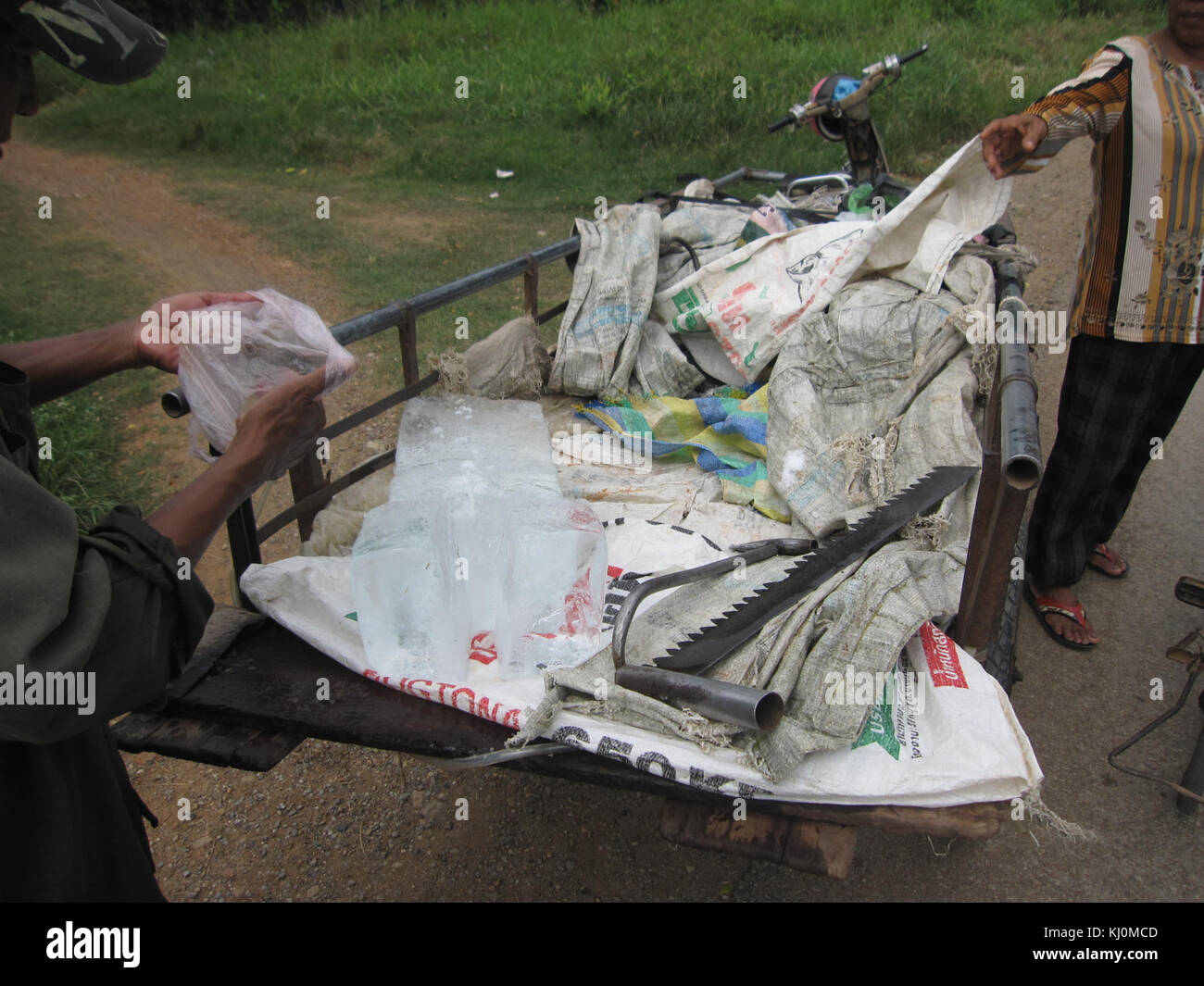 A historical photograph capturing ice production in Cambodia. The image ...