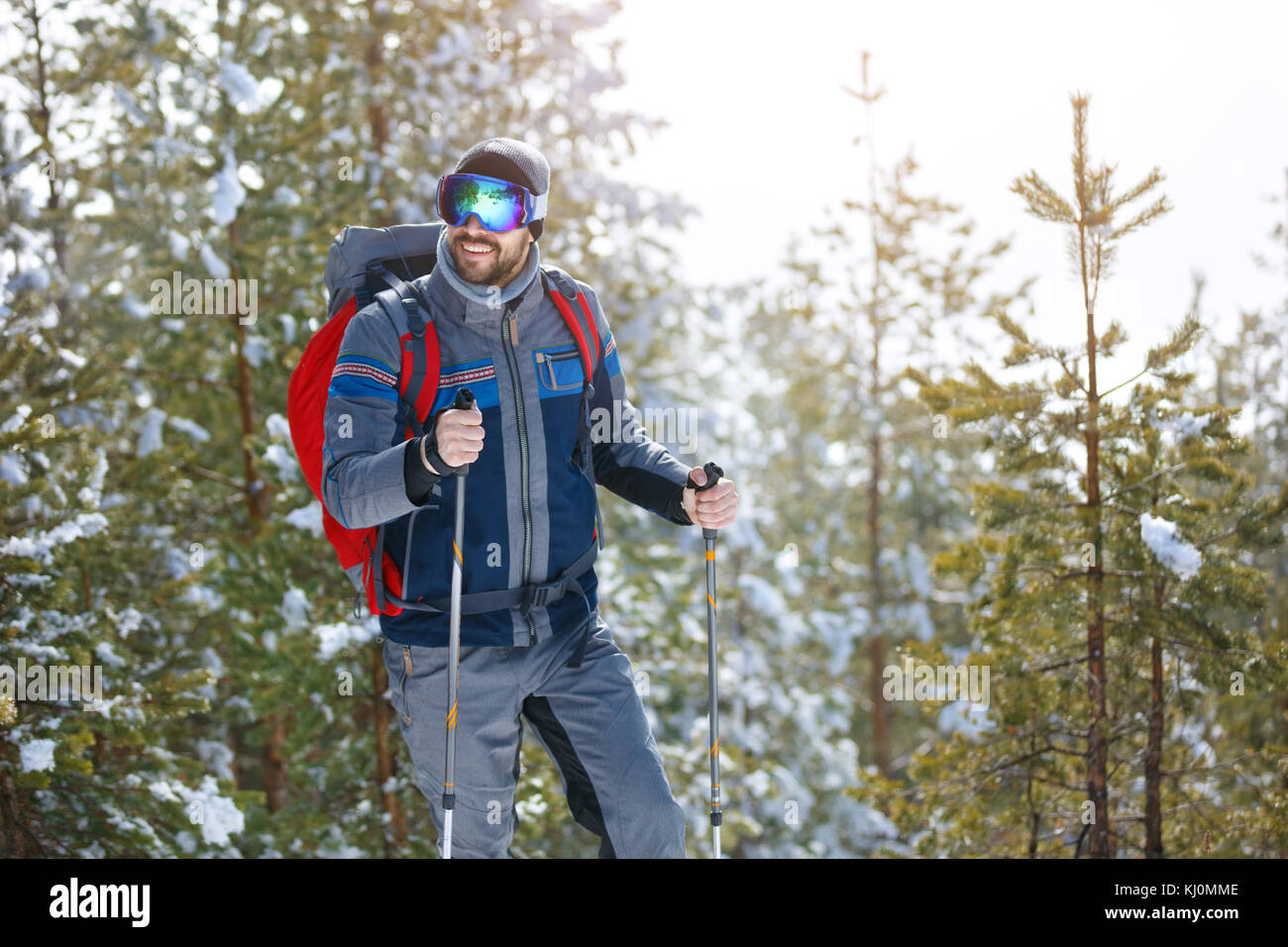 Man hiking at winter in snowy wood Stock Photo - Alamy