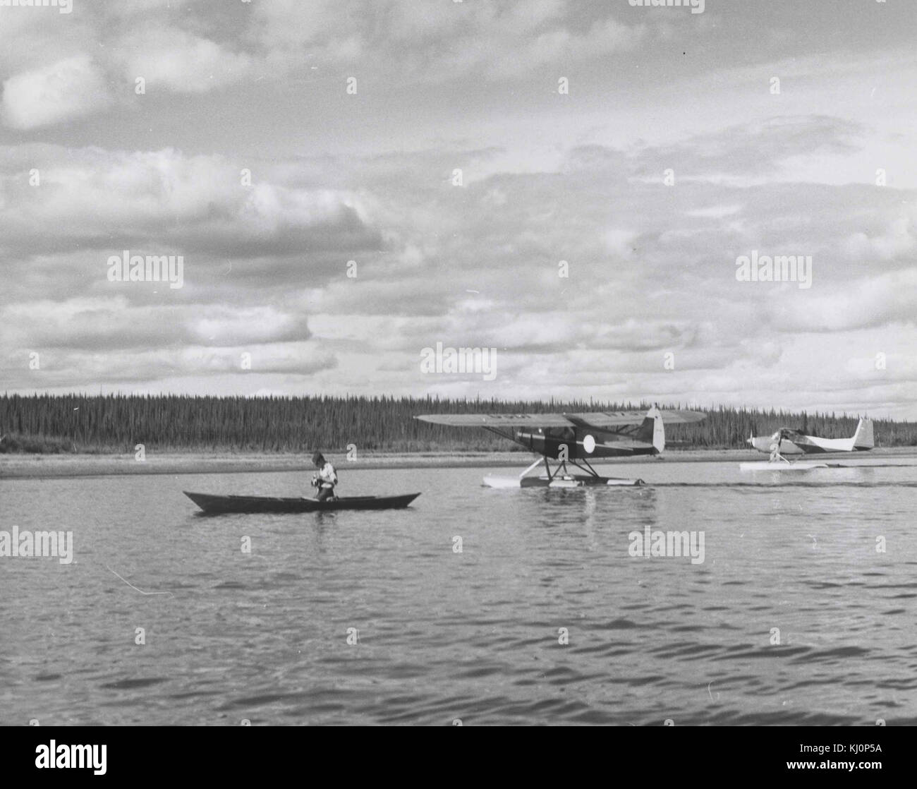 History vintage photo canoe and two float planes Stock Photo - Alamy