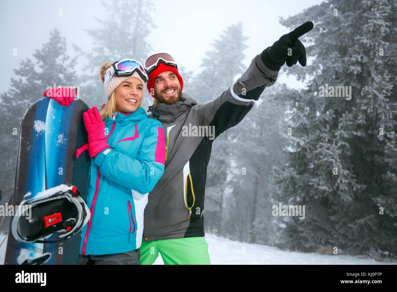 smiling couple snowboarder enjoying at ski resort in the mountain Stock ...