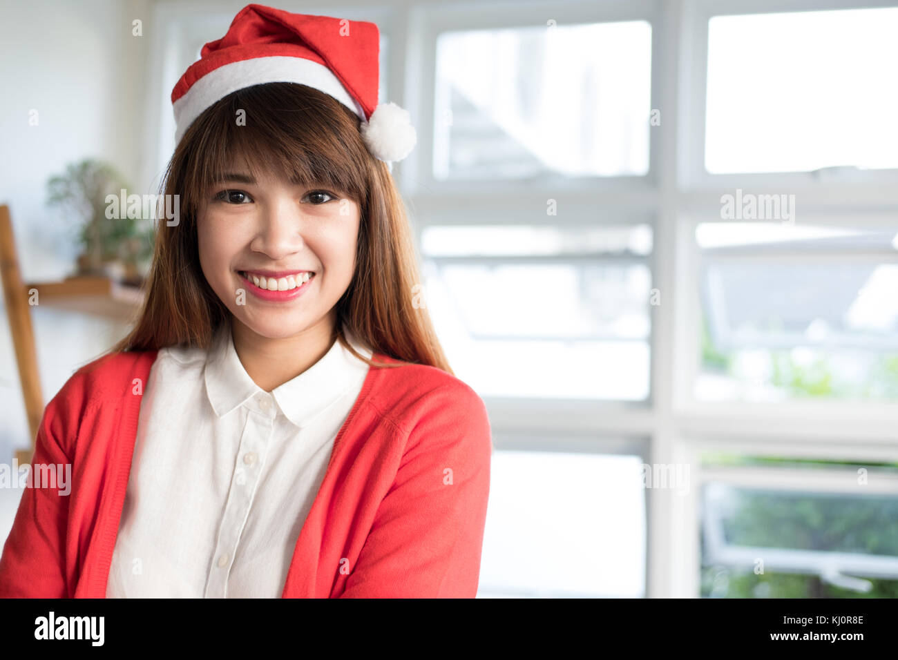 asian woman wear santa hat. asian female wear white shirt and red ...