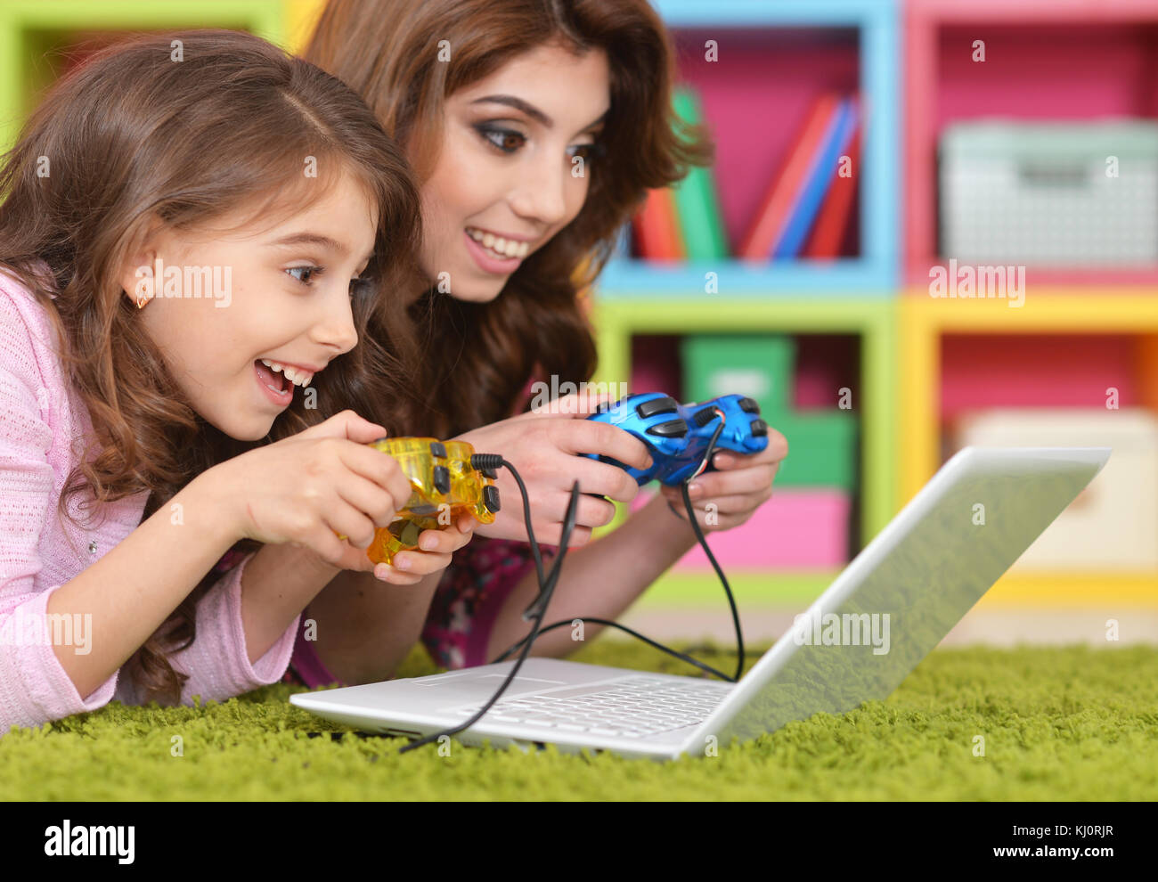 mother and daughter playing game on laptop Stock Photo - Alamy