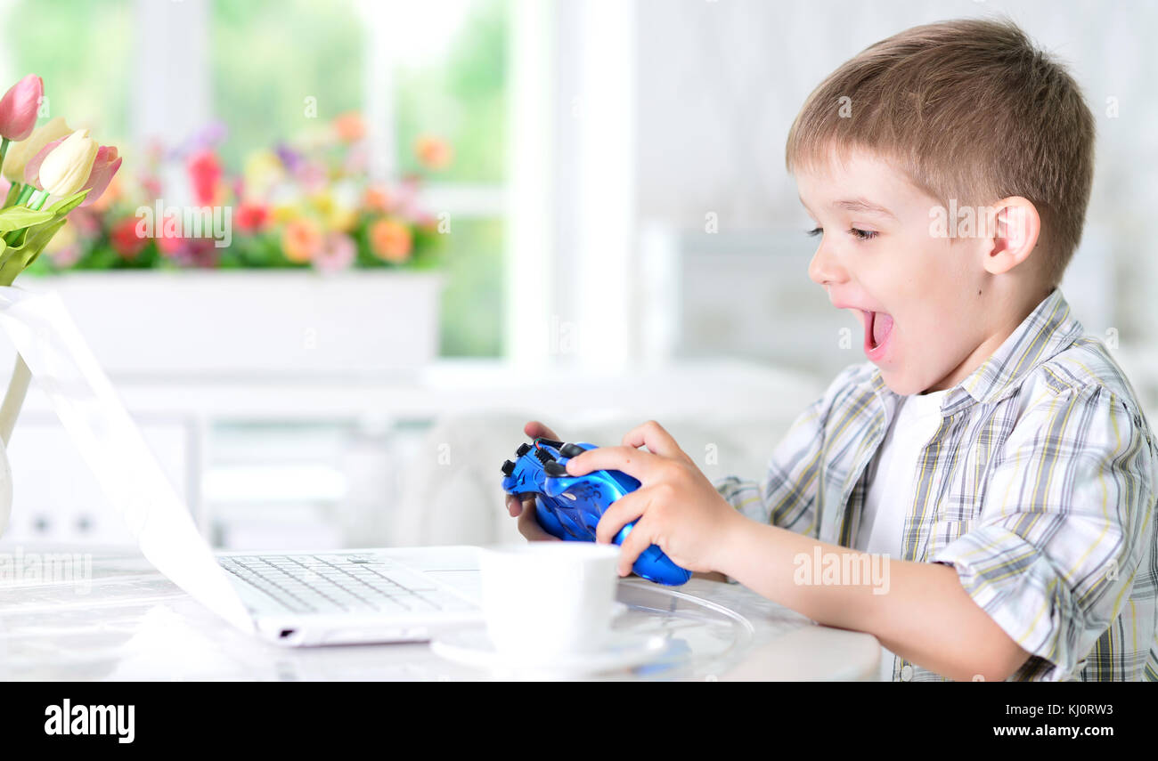 Emotional boy playing computer game Stock Photo - Alamy